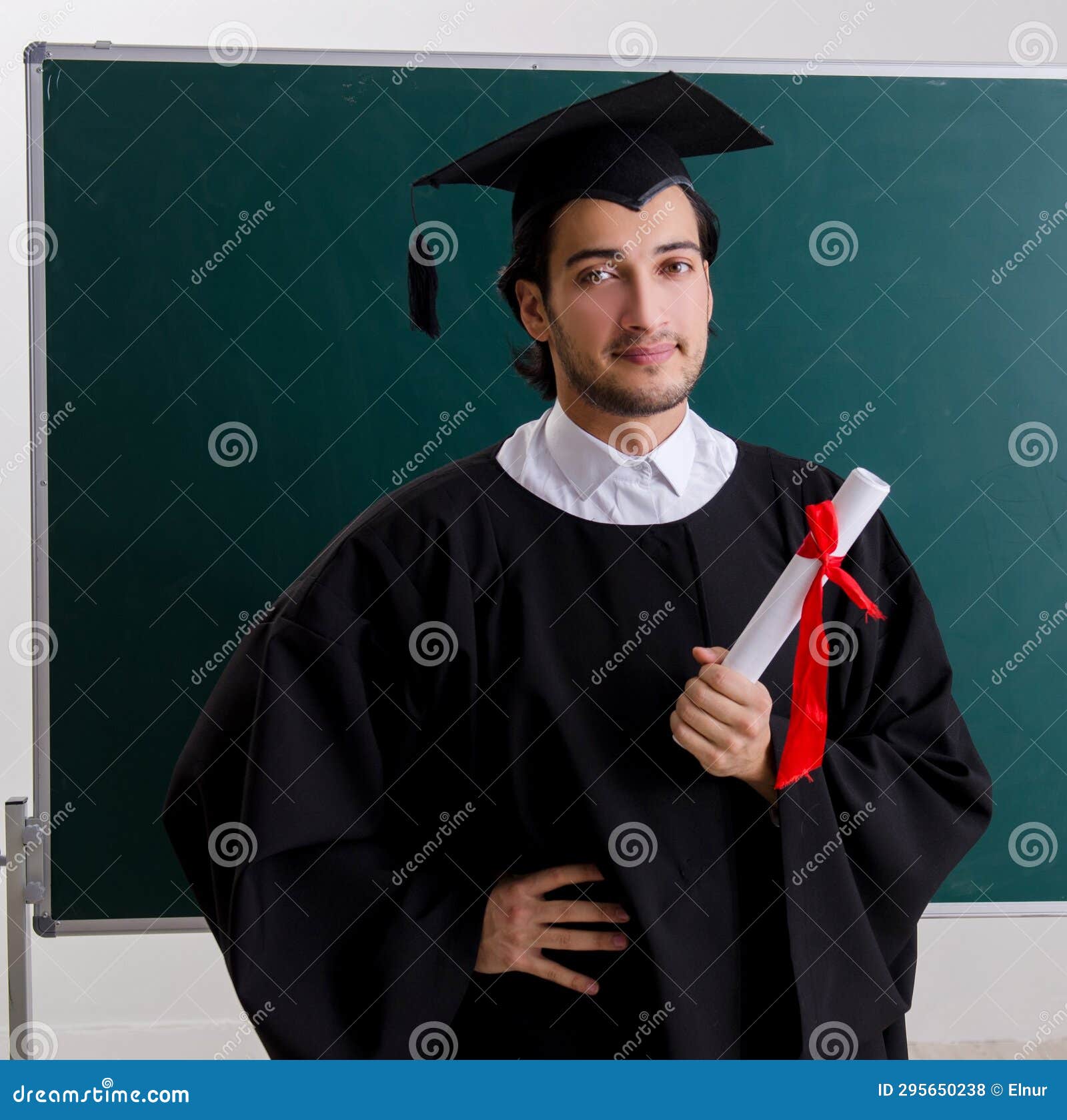 Graduate Student in Front of Green Board Stock Photo - Image of male ...