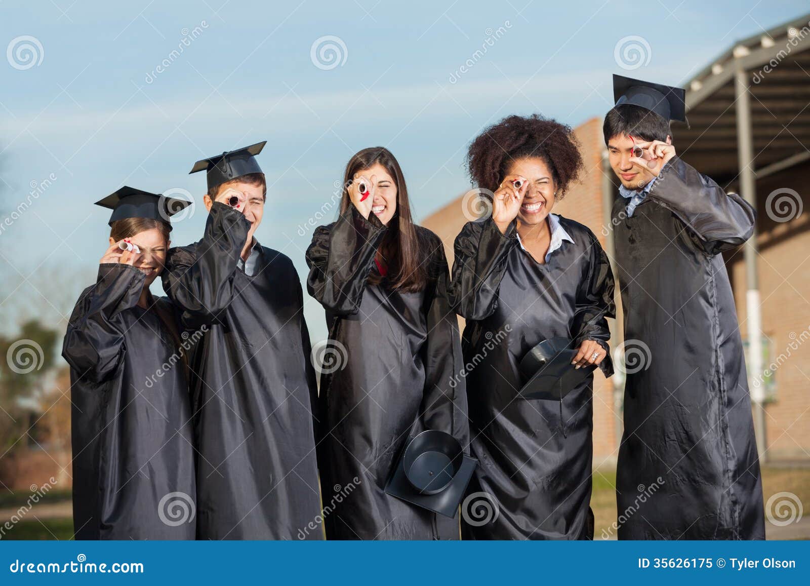 Graduate Students Looking through Diplomas on Stock Image - Image of ...