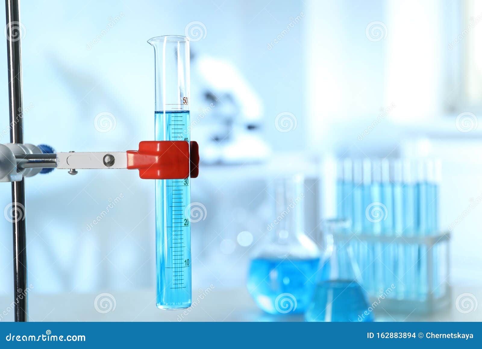 Graduated Cylinder with Light Blue Liquid in Laboratory Stock Photo ...