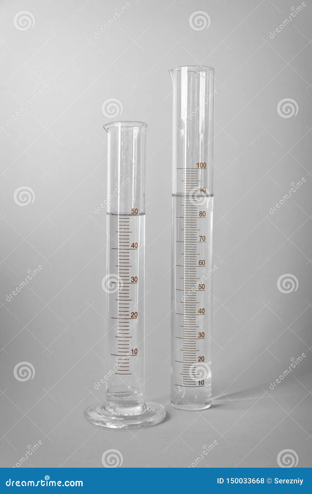 Graduated Cylinders with Water on Light Background Stock Photo - Image ...