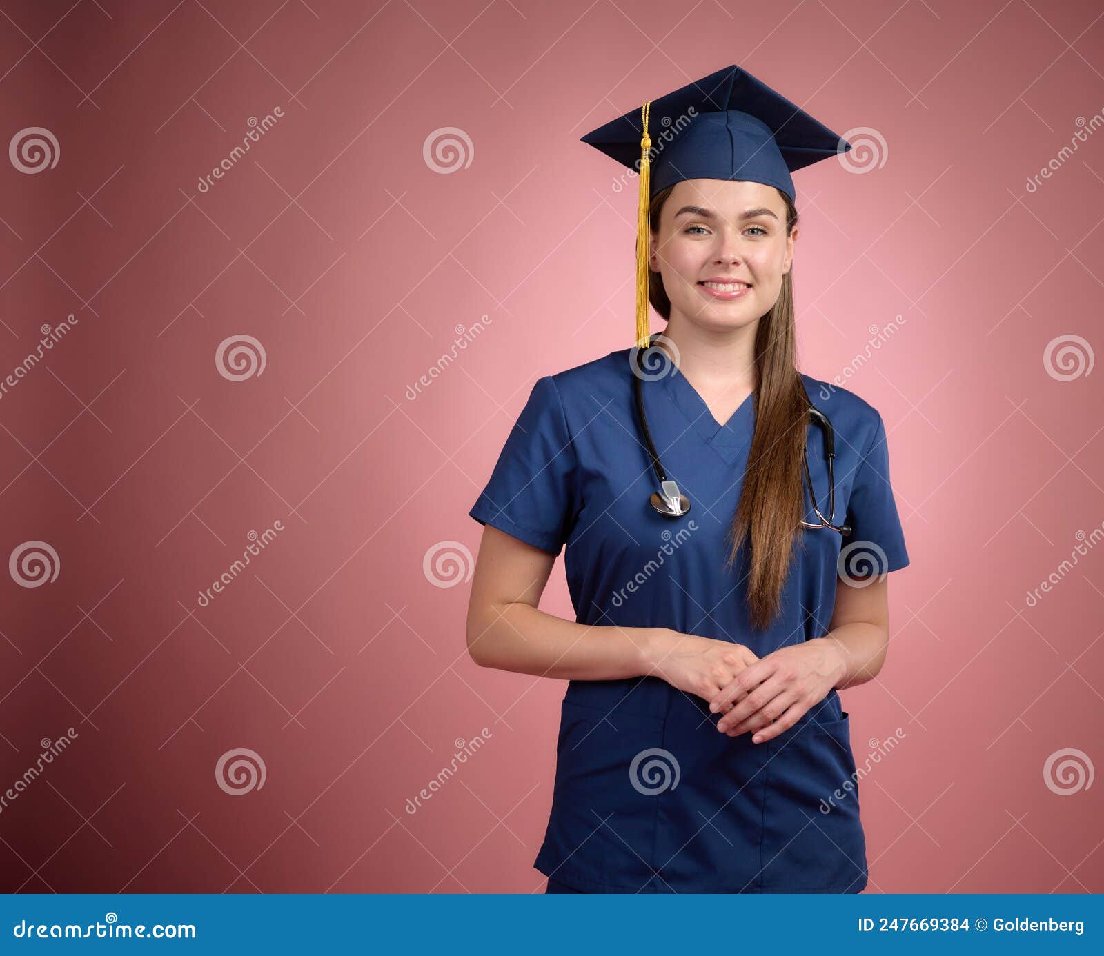 Graduated Nurse In Blue Uniform In Graduation Cap Standing And Holding ...