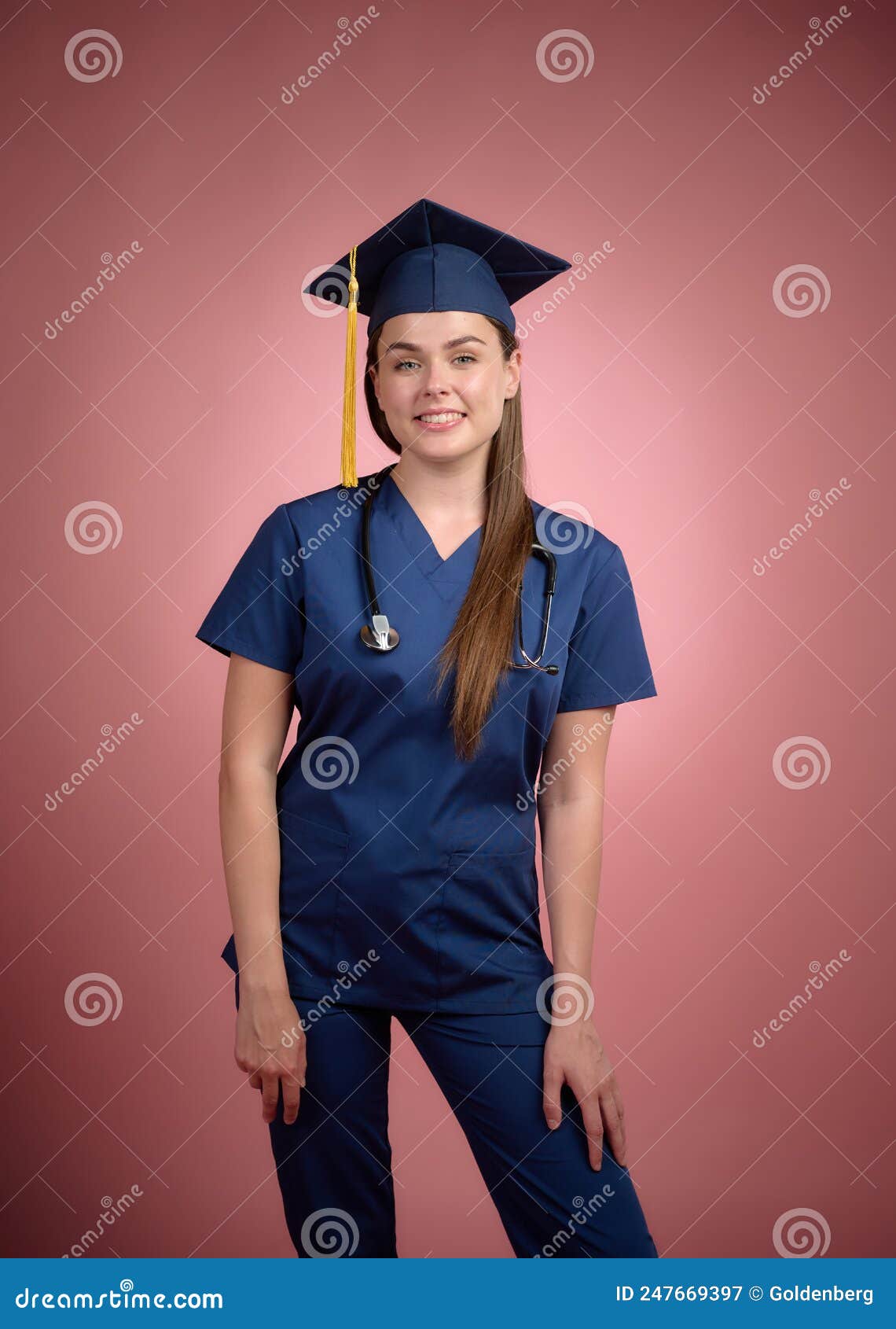 Graduated Nurse In Blue Uniform In Graduation Cap Standing And Holding ...