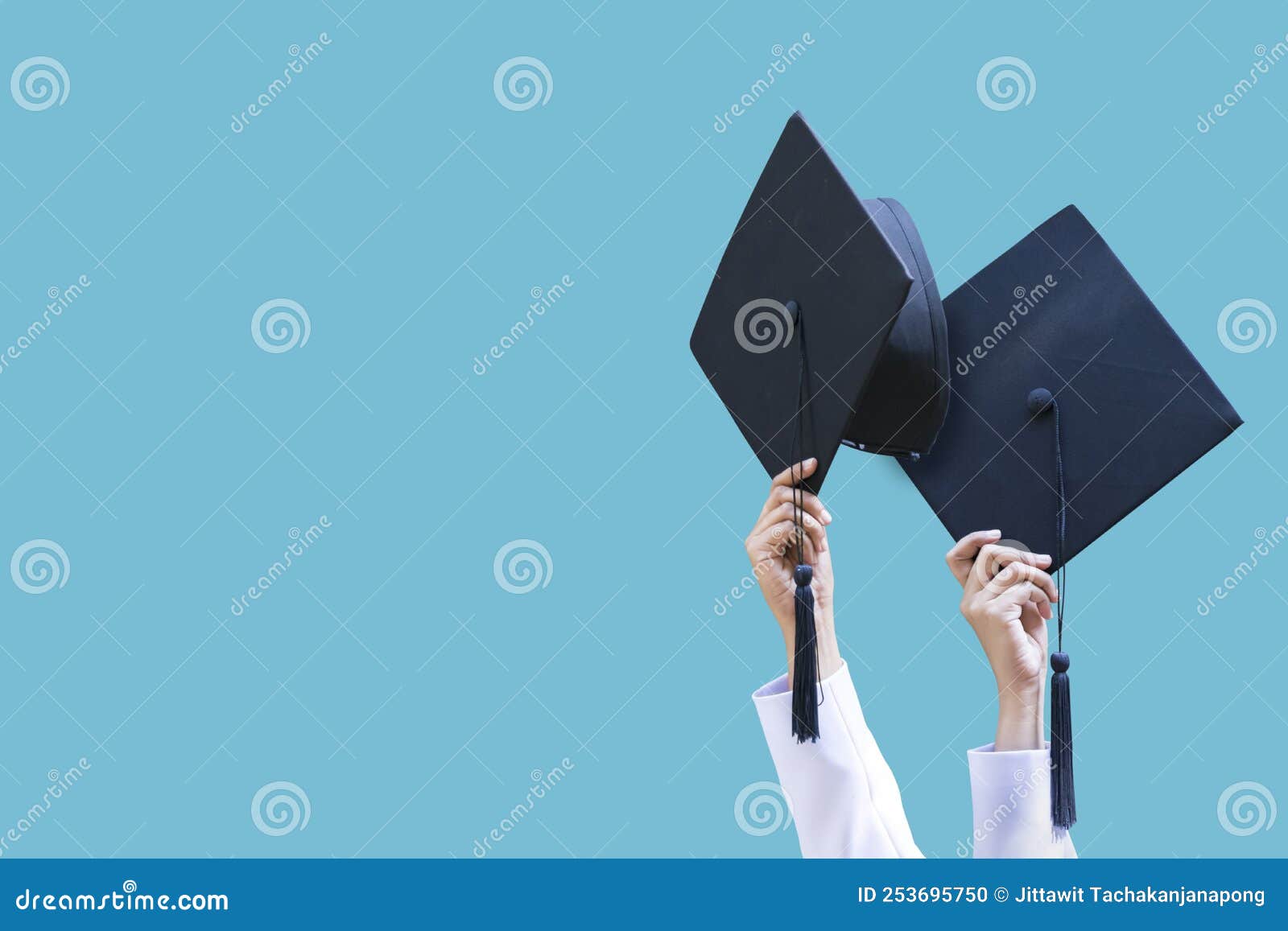 Graduates Student Graduation Caps Thrown on a Blue Isolated Stock Photo ...
