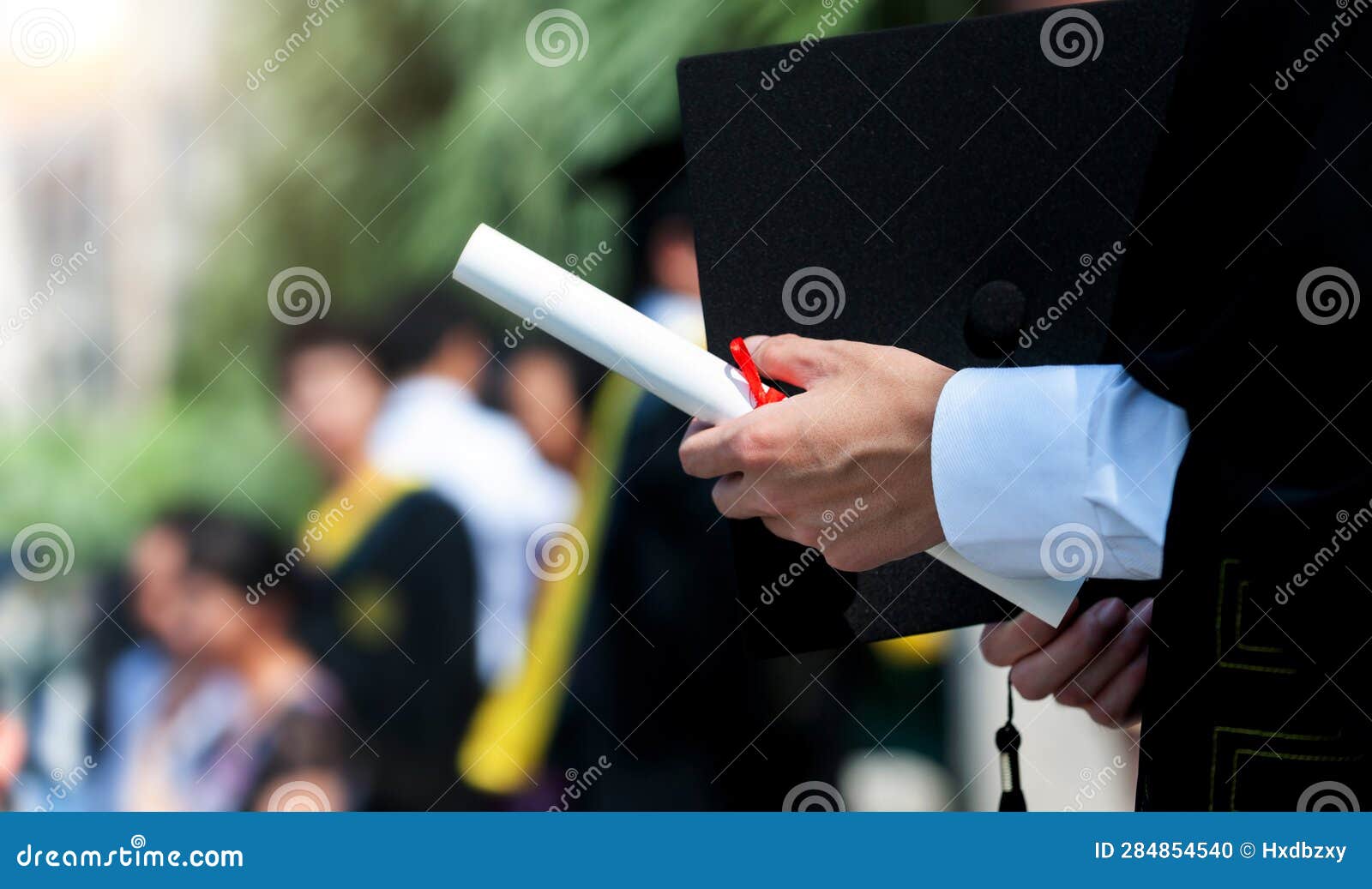 Graduating Student Holding Their Diploma Stock Photo - Image of ...