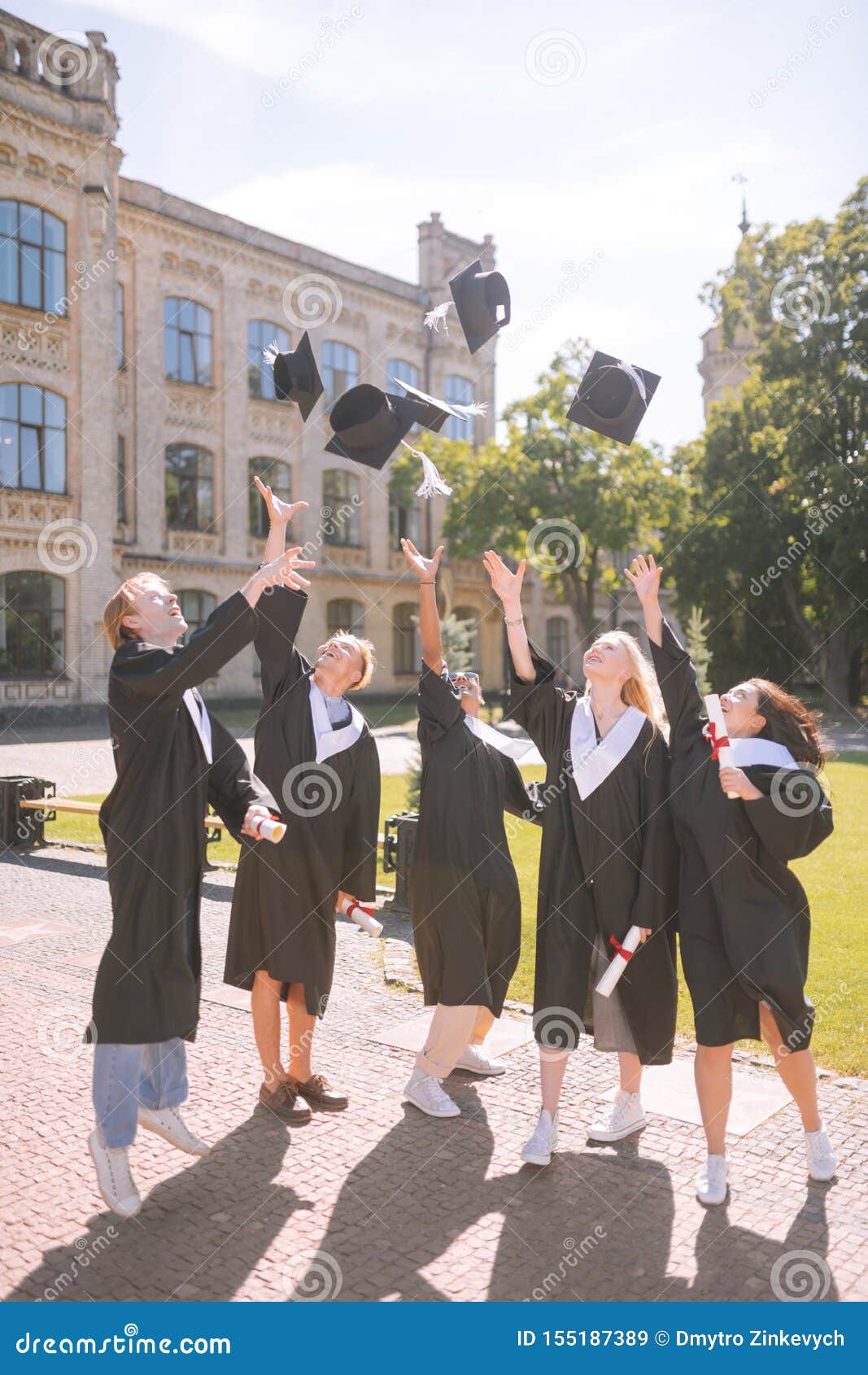 Graduating Students Throwing Their Masters Caps Up. Stock Image - Image ...