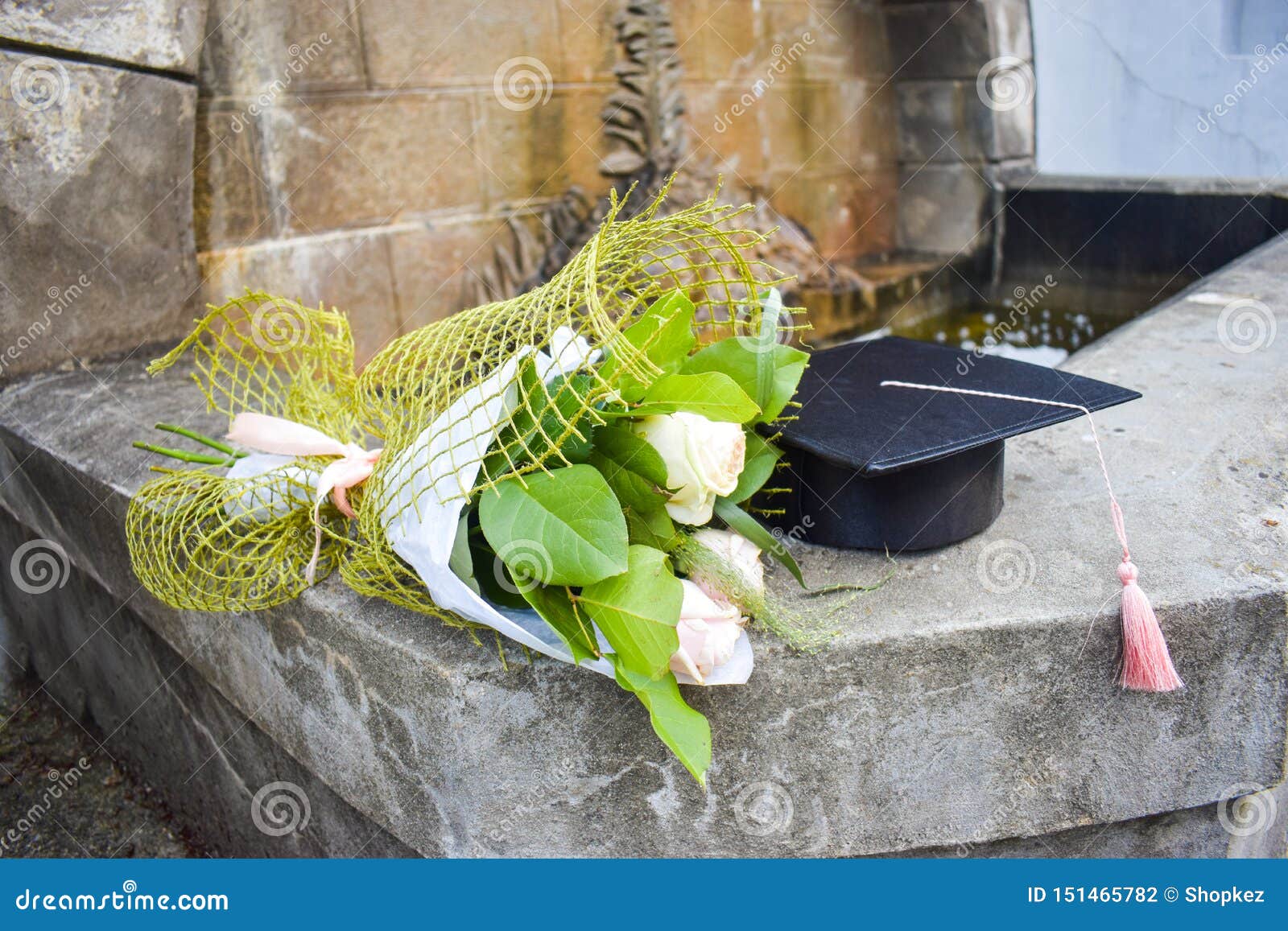 Graduation Cap or Mortaboard with a Bunch of Roses on the Old Stairs in ...