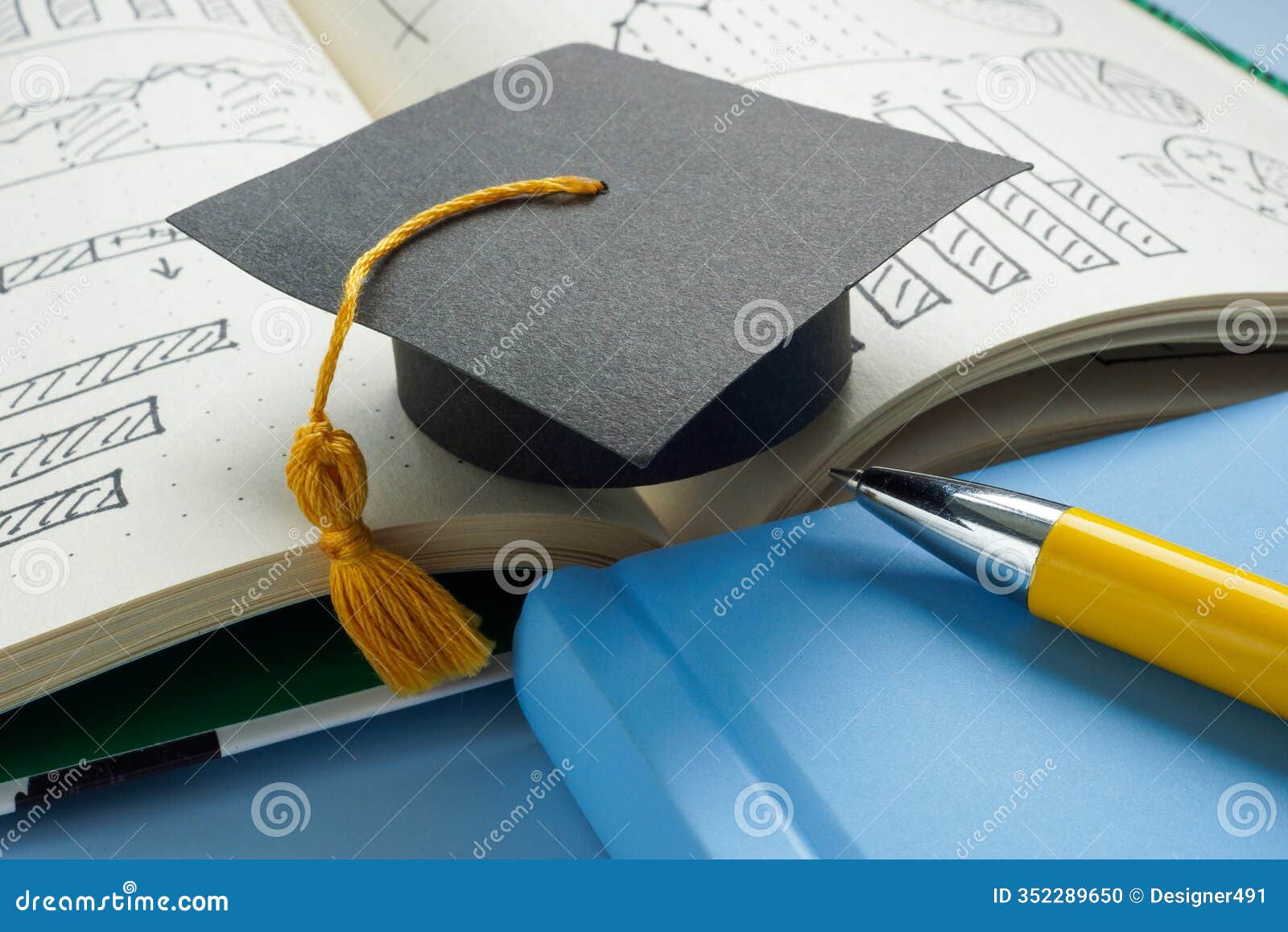 Graduation Cap on a Notebook with Business Notes. Symbol of Education ...