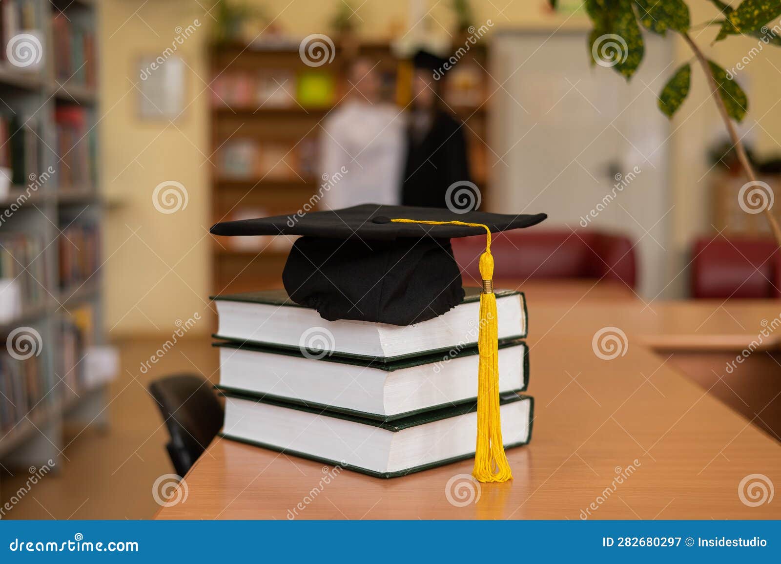 Graduation Cap on a Stack of Books in the Library. Stock Image - Image ...