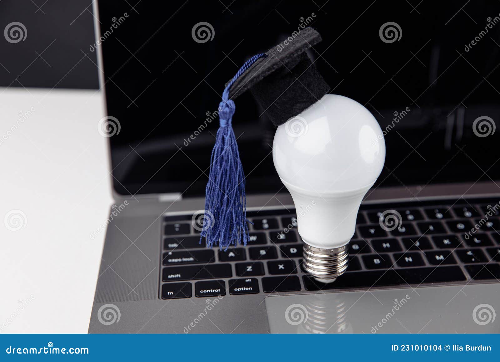 Graduation Hat on Light Bulb on Laptop. Online Education Concept Stock ...