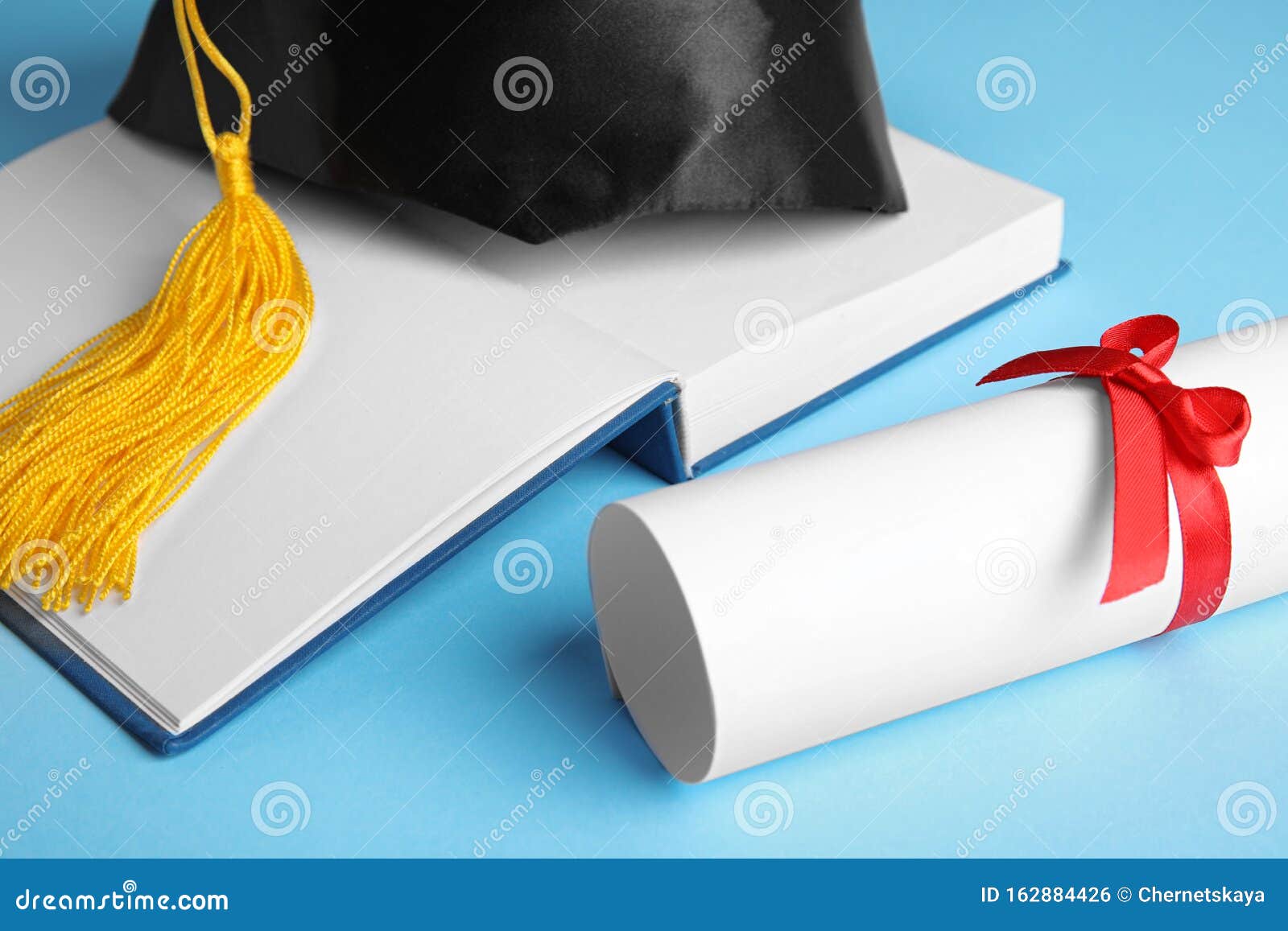 Graduation Hat, Open Book and Student`s Diploma on Blue Background ...