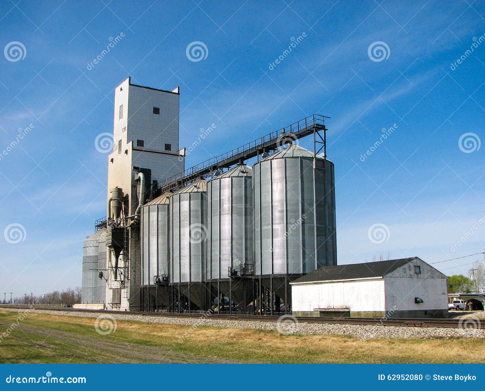 Grain Elevator and Bins with Blue Sky Stock Photo - Image of tracks ...