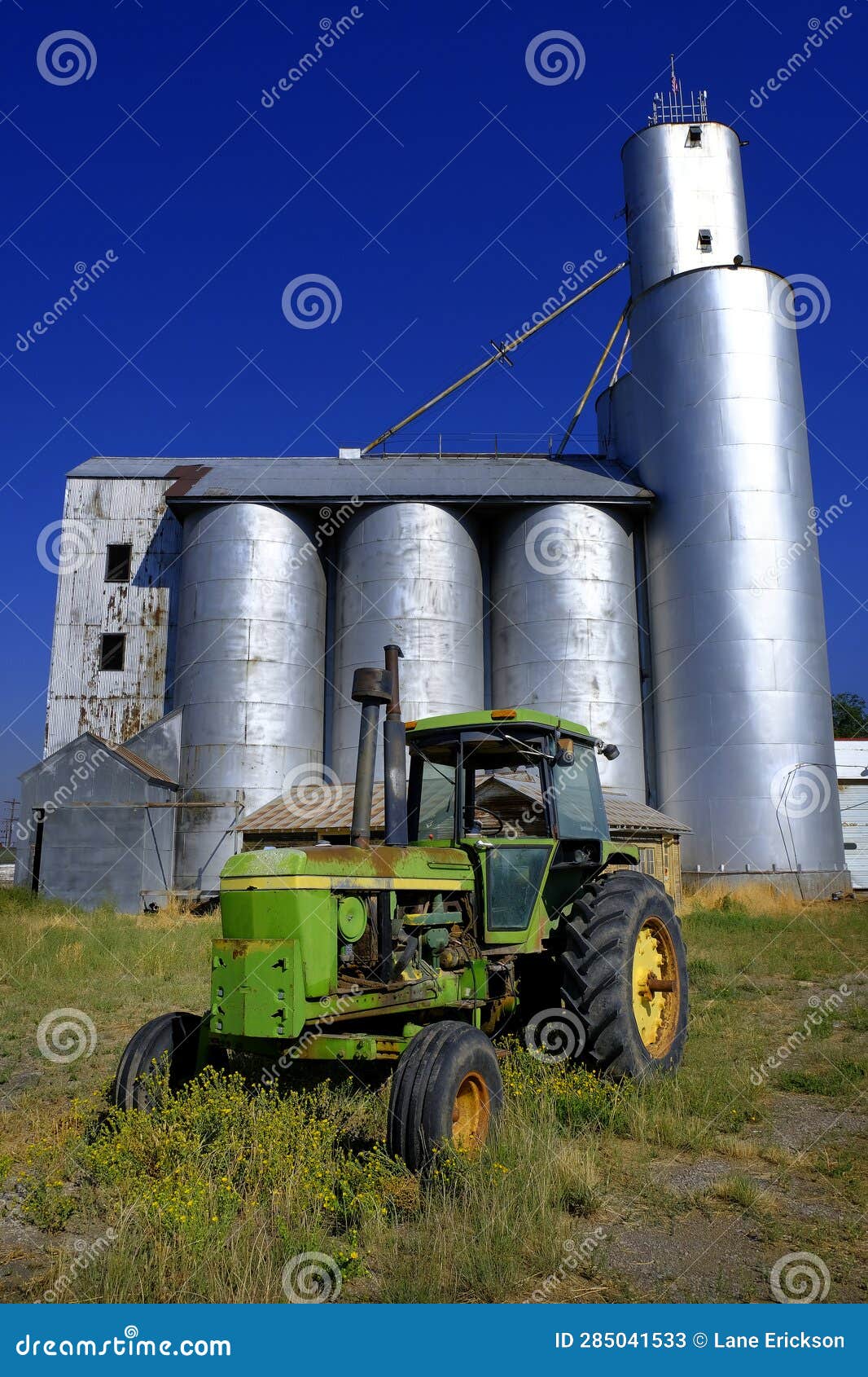 Grain Elevator Silo with Old Green Tractor Stock Image - Image of ...