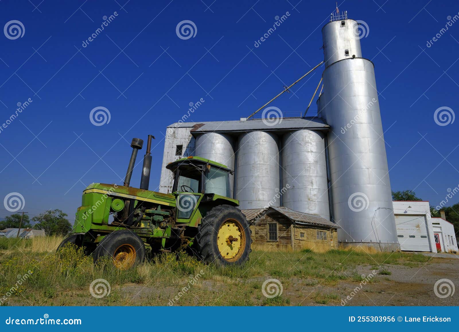 Grain Elevator Silo with Old Green Tractor Stock Photo - Image of ...