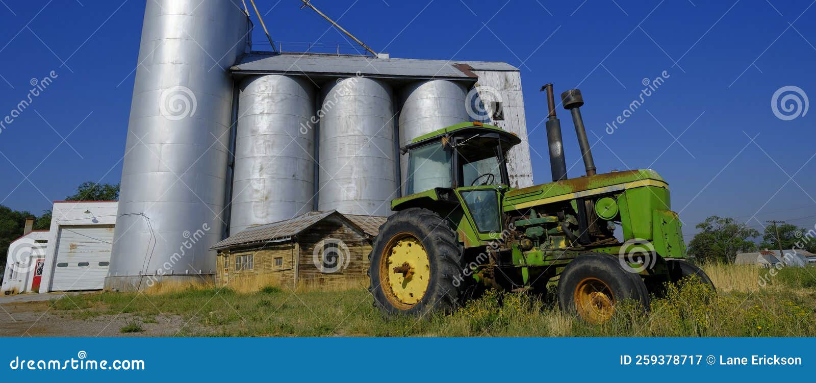 Grain Elevator Silo with Old Green Tractor Stock Image - Image of ...