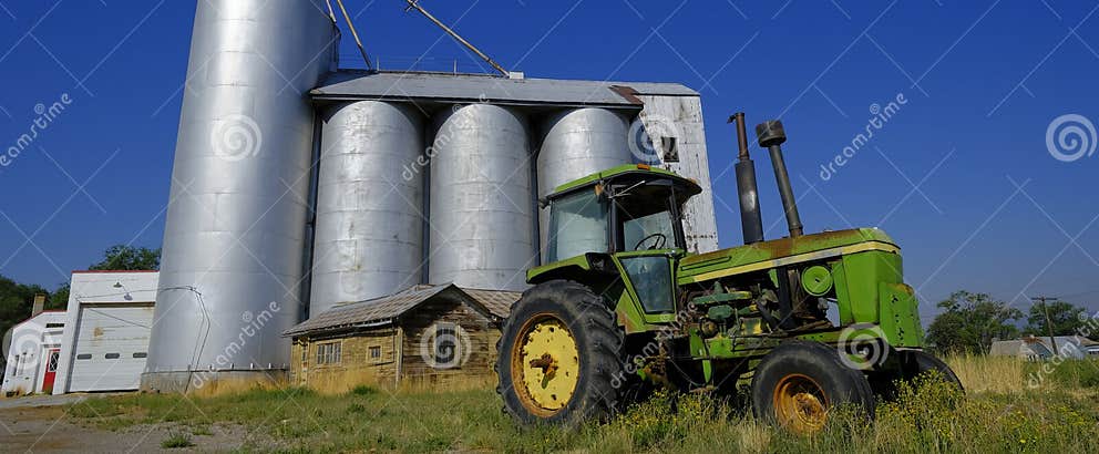 Grain Elevator Silo with Old Green Tractor Stock Image - Image of ...