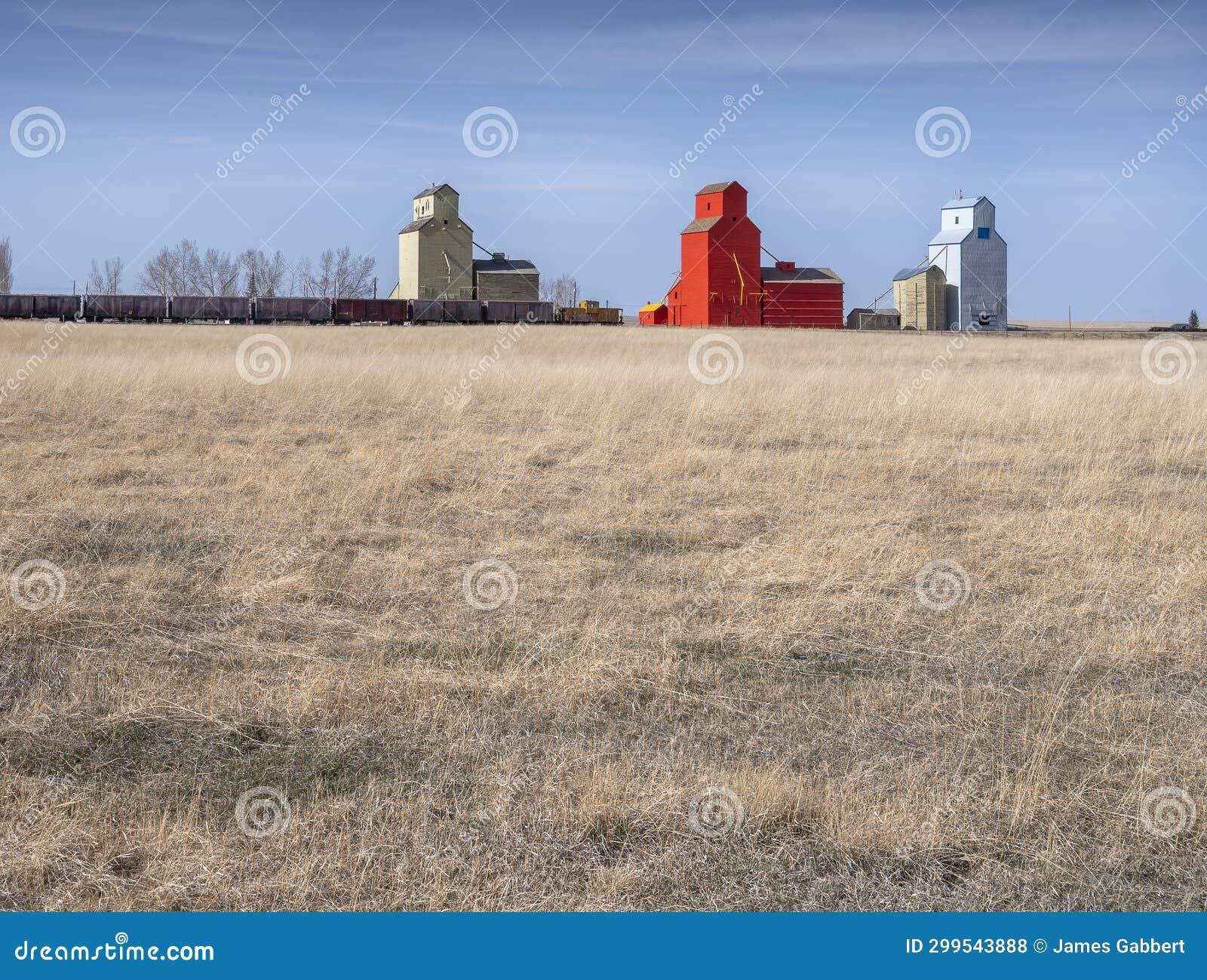 Distant Train and Grain Elevators Stock Photo - Image of outdoors ...