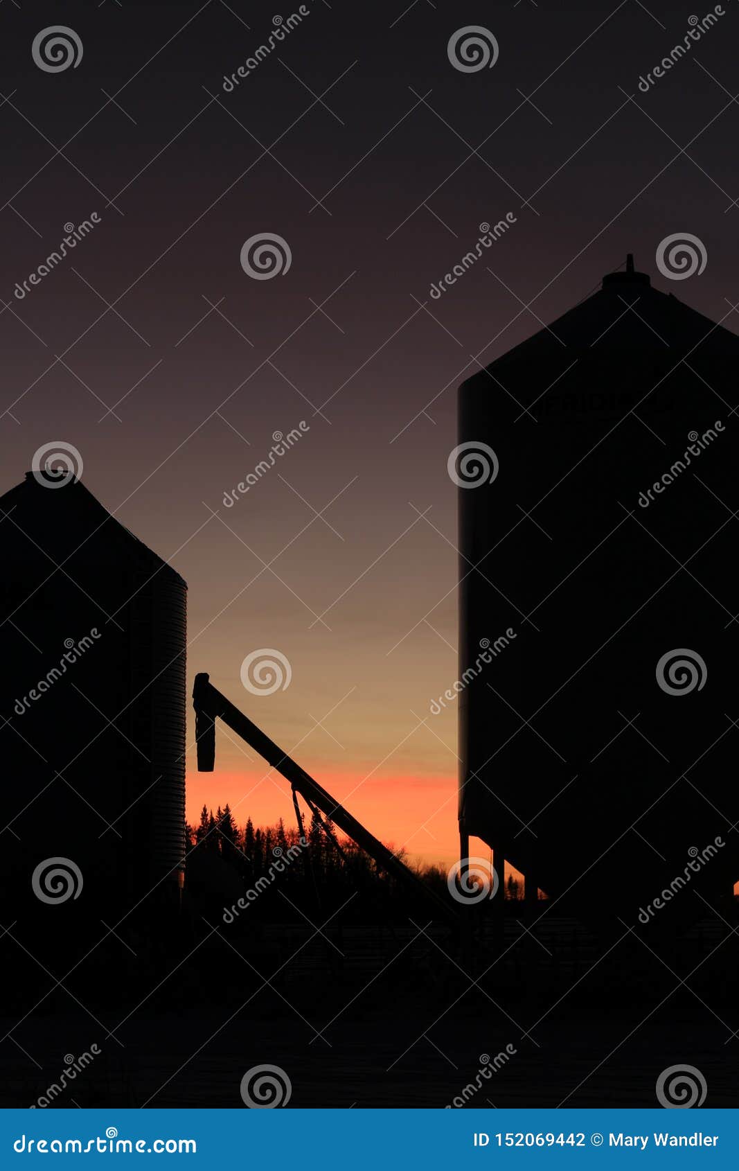 Grain Silos on Farmland Silhouetted by a Sunset. Alberta Stock Photo ...