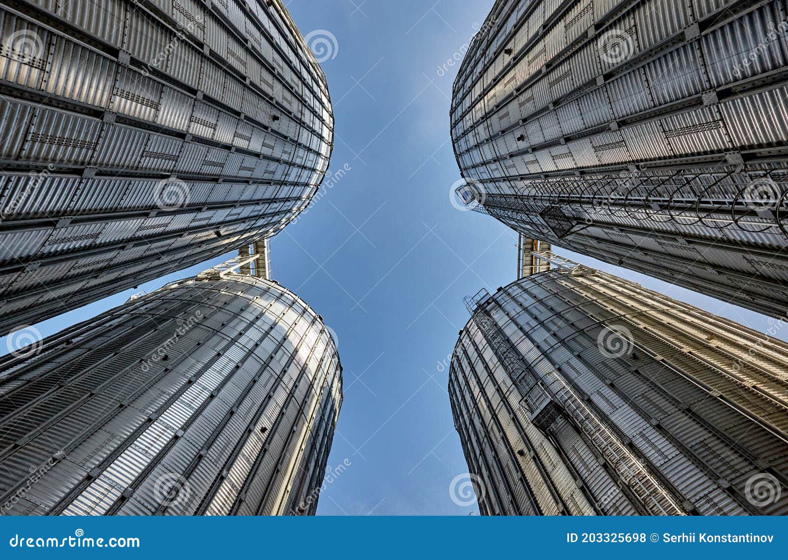 Grain Storage Tanks at a Grain Elevator Against a Blue Sky Stock Photo ...