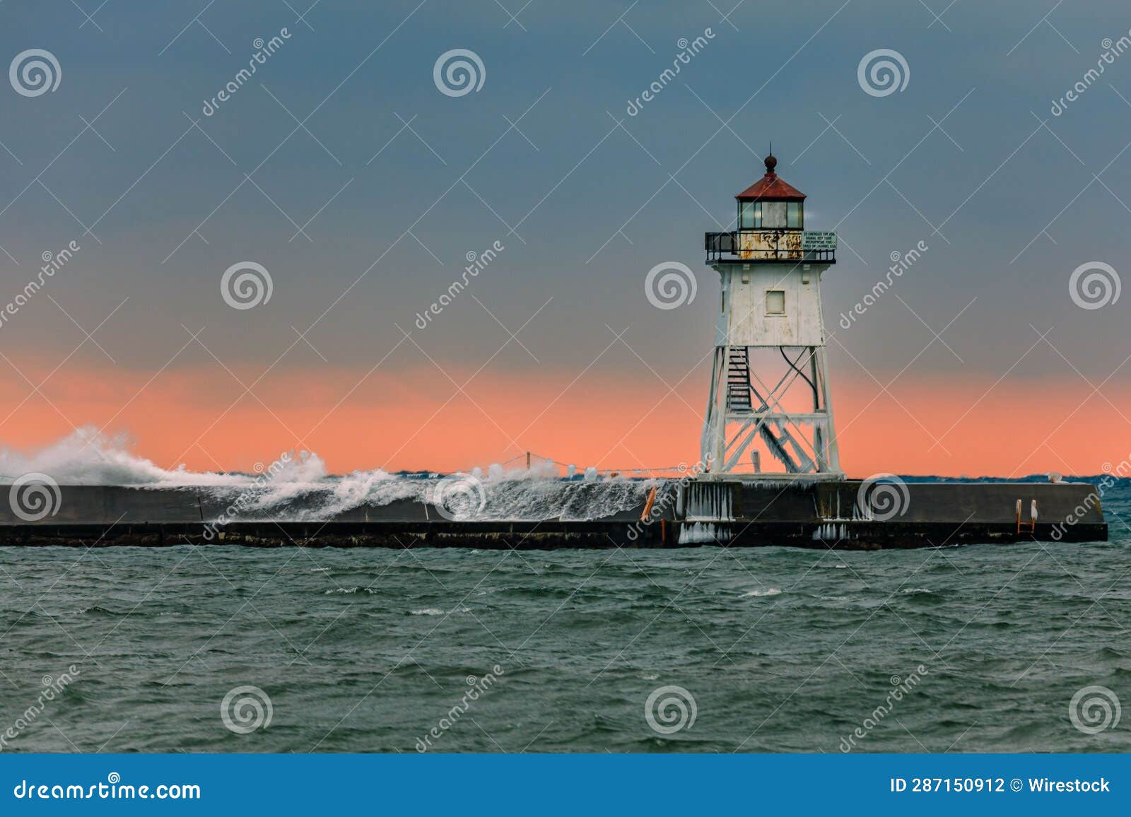 Grand Marais Lighthouse Illuminated by a Vibrant Sunset, with the Sky ...