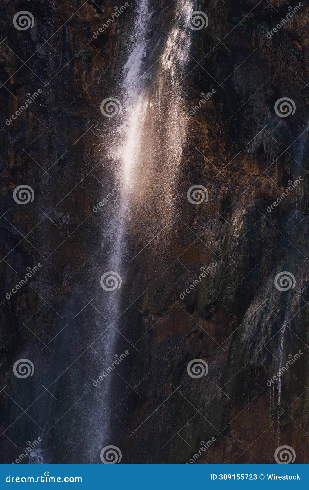 A Large Waterfall Running Down the Side of a Cliff Face Stock Image ...