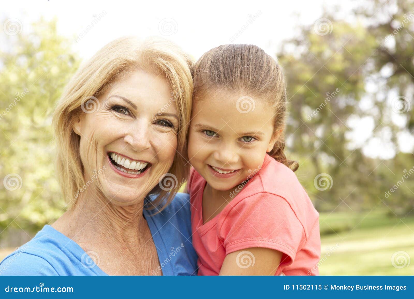 Grandaughter Hugging Grandmother in Park Stock Image - Image of ...