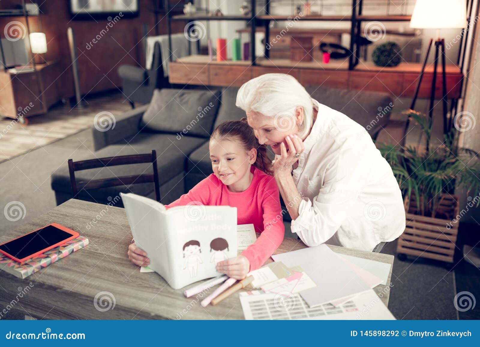 Granddaughter Feeling Involved in Reading the Book with Granny Stock ...