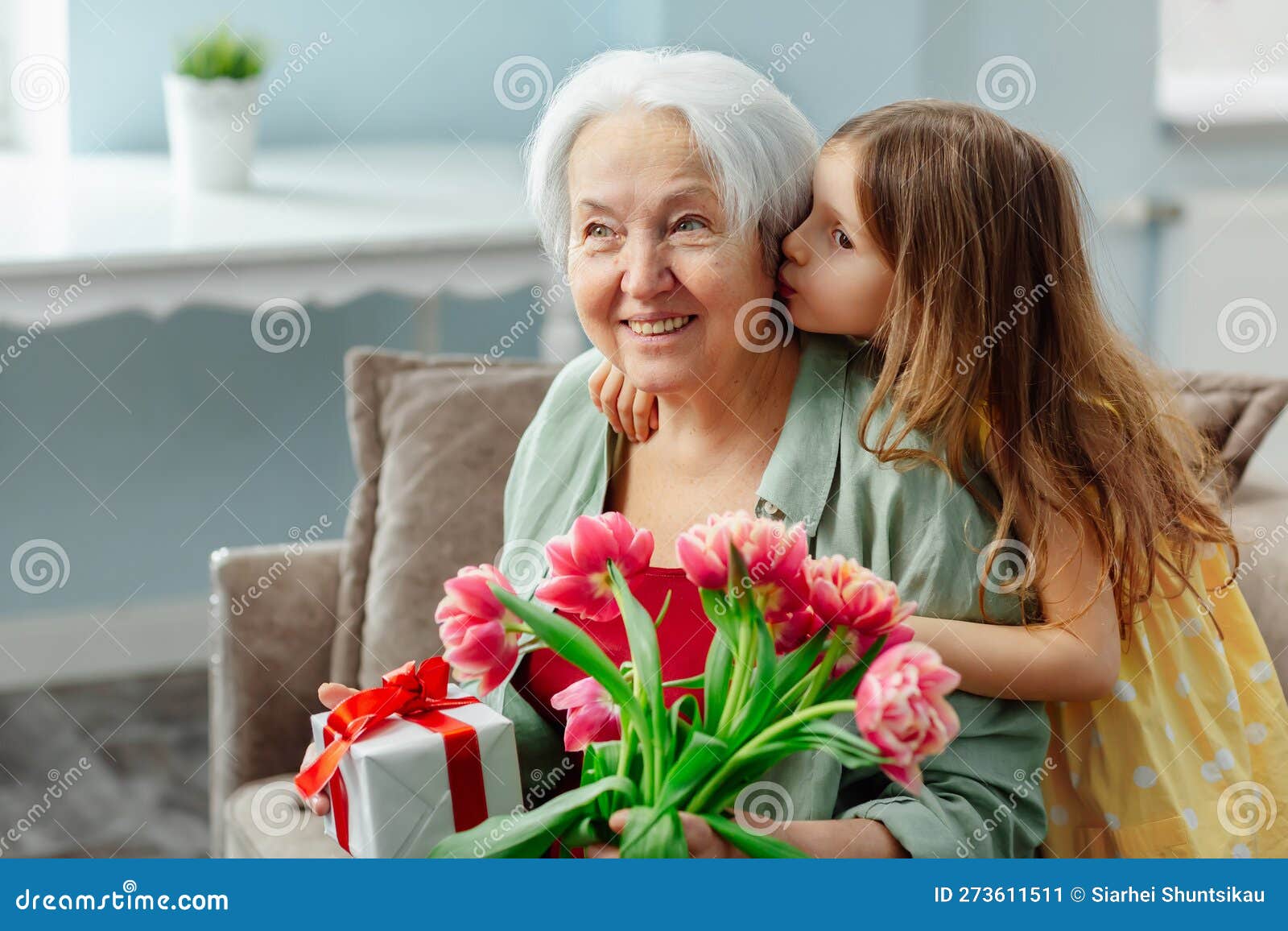 The Granddaughter Gave Her Grandmother A Bouquet Of Flowers And A T