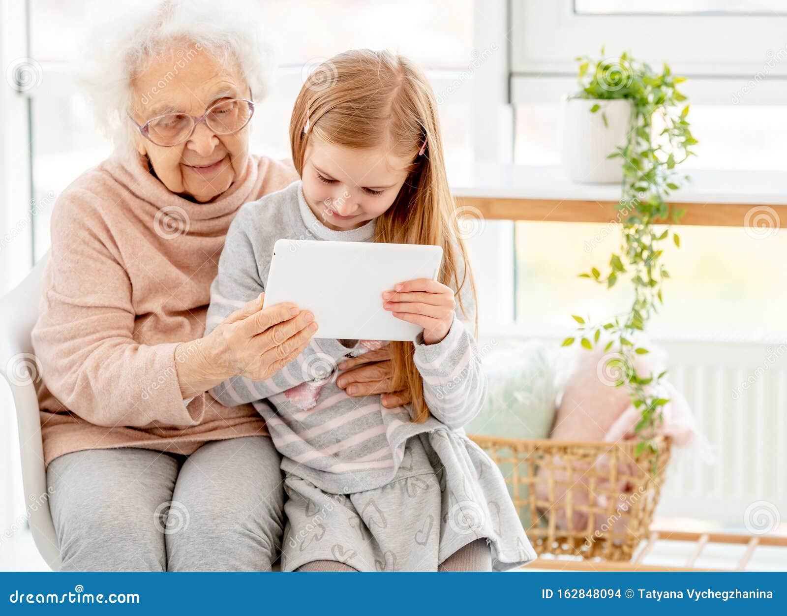 Granddaughter with Granny Using Tablet Stock Photo - Image of cute ...