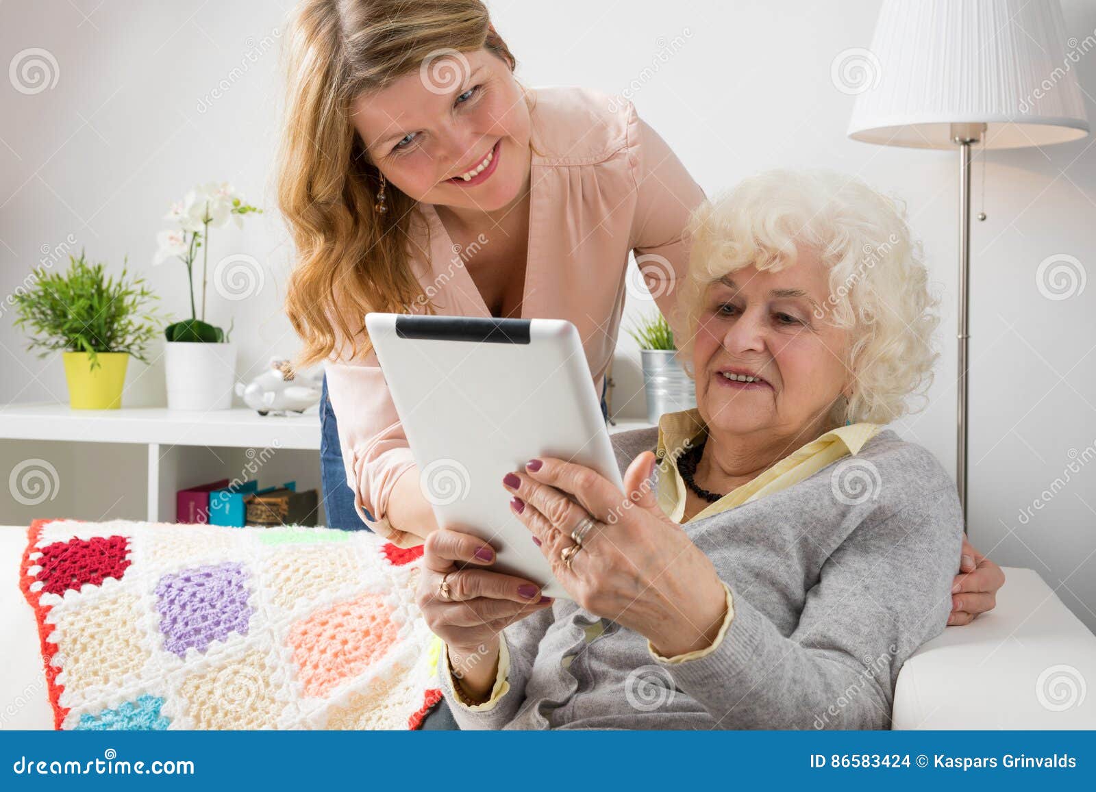 Granddaughter Teaching Grandma How To Use Tablet Computer Stock Photo ...