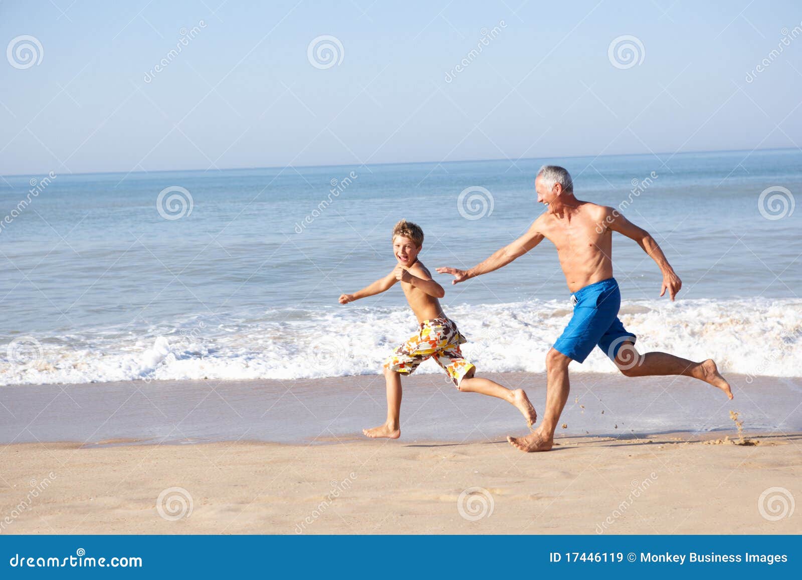 Grandfather Chasing Young Boy On Beach Royalty-Free Stock Photo ...