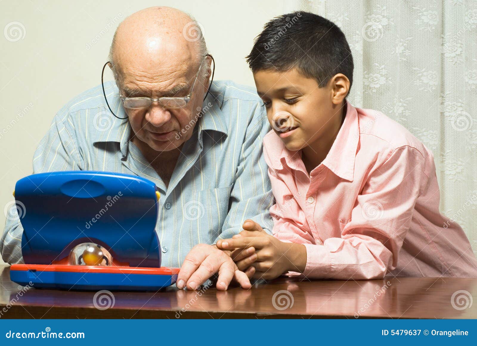 Grandfather and Grandson Looking at a Toy Computer Stock Image - Image ...