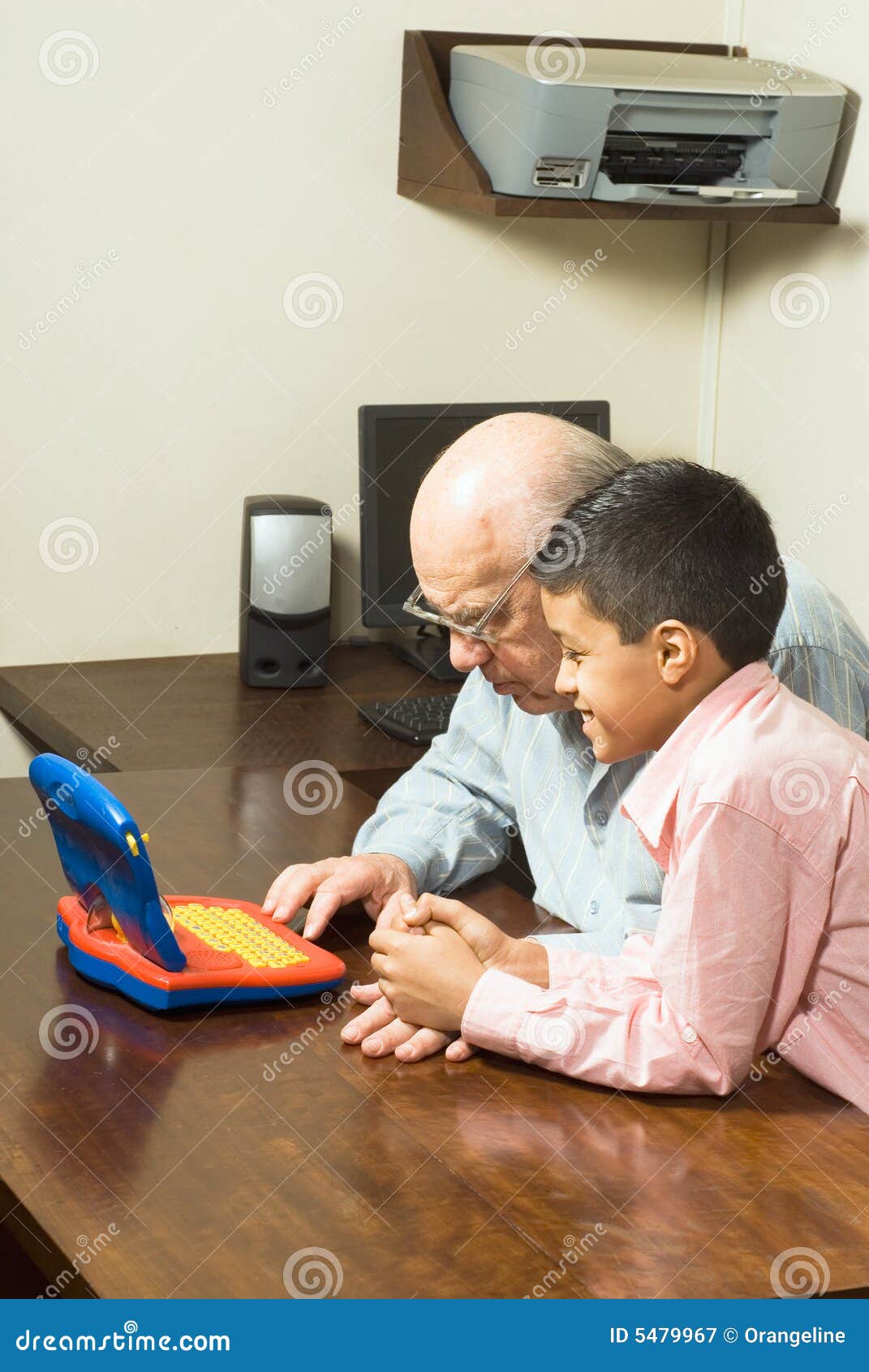 Grandfather And Grandson Looking At A Toy Computer Picture. Image: 5479967