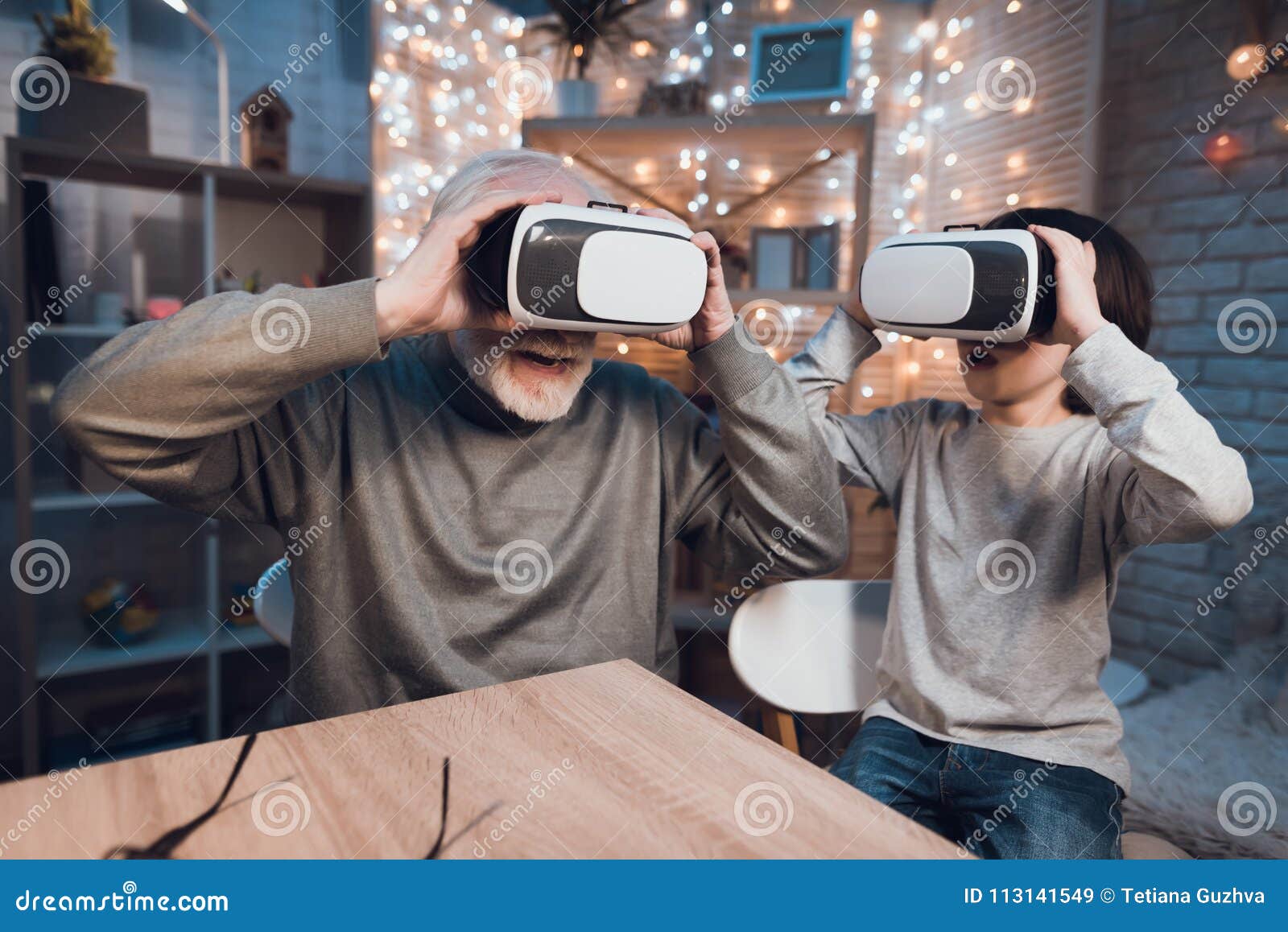 Grandfather and Grandson are Using Virtual Reality at Night at Home ...