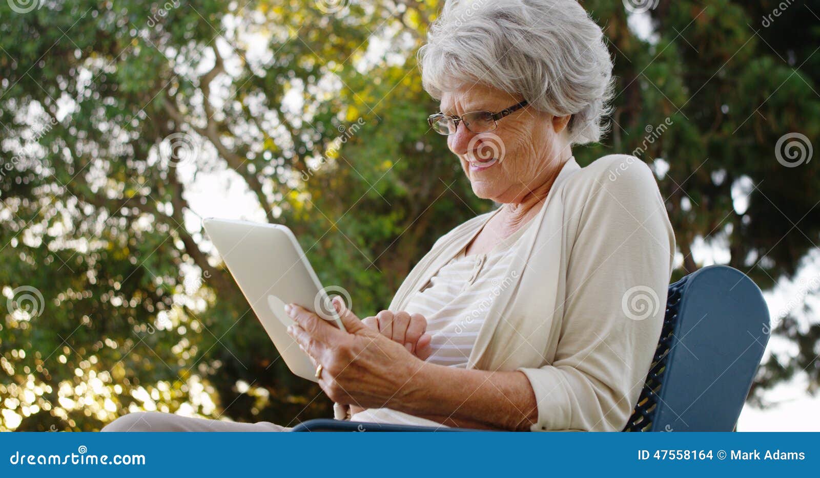 Grandma Using Tablet at the Park Stock Photo - Image of relaxing ...