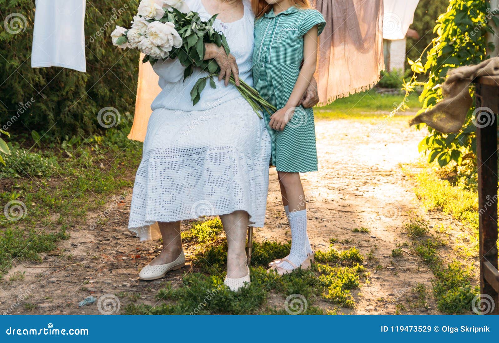 Grandmother Elderly Woman Sitting And Hugging Her Granddaughter Girl