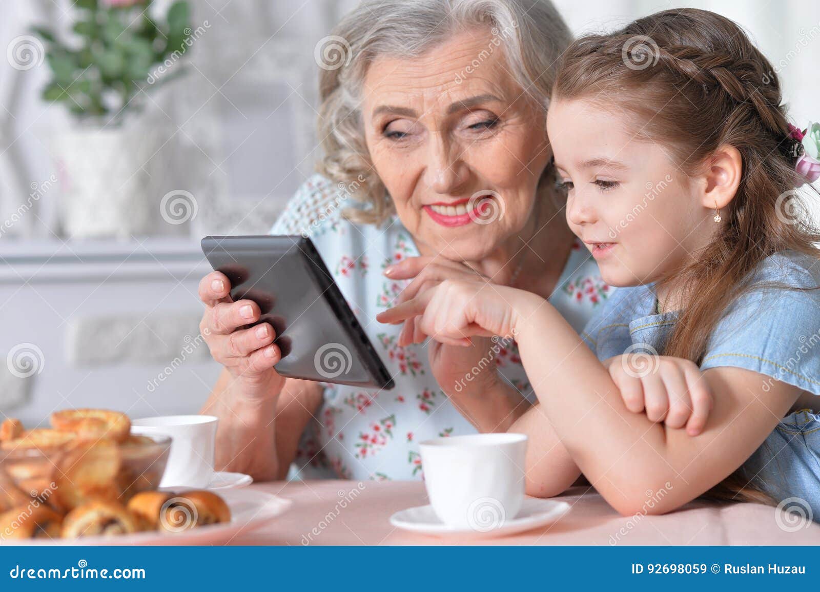 Grandmother with Granddaughter Playing in a Tablet Stock Image - Image ...