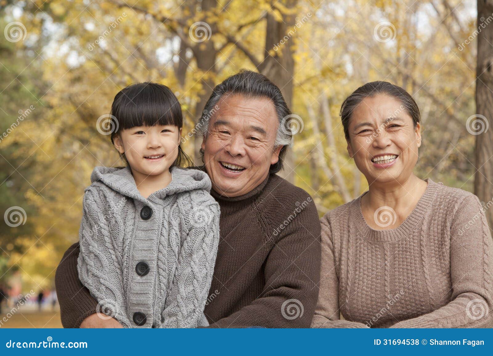 Grandparents and Granddaughter in Park Stock Photo - Image of cheerful ...