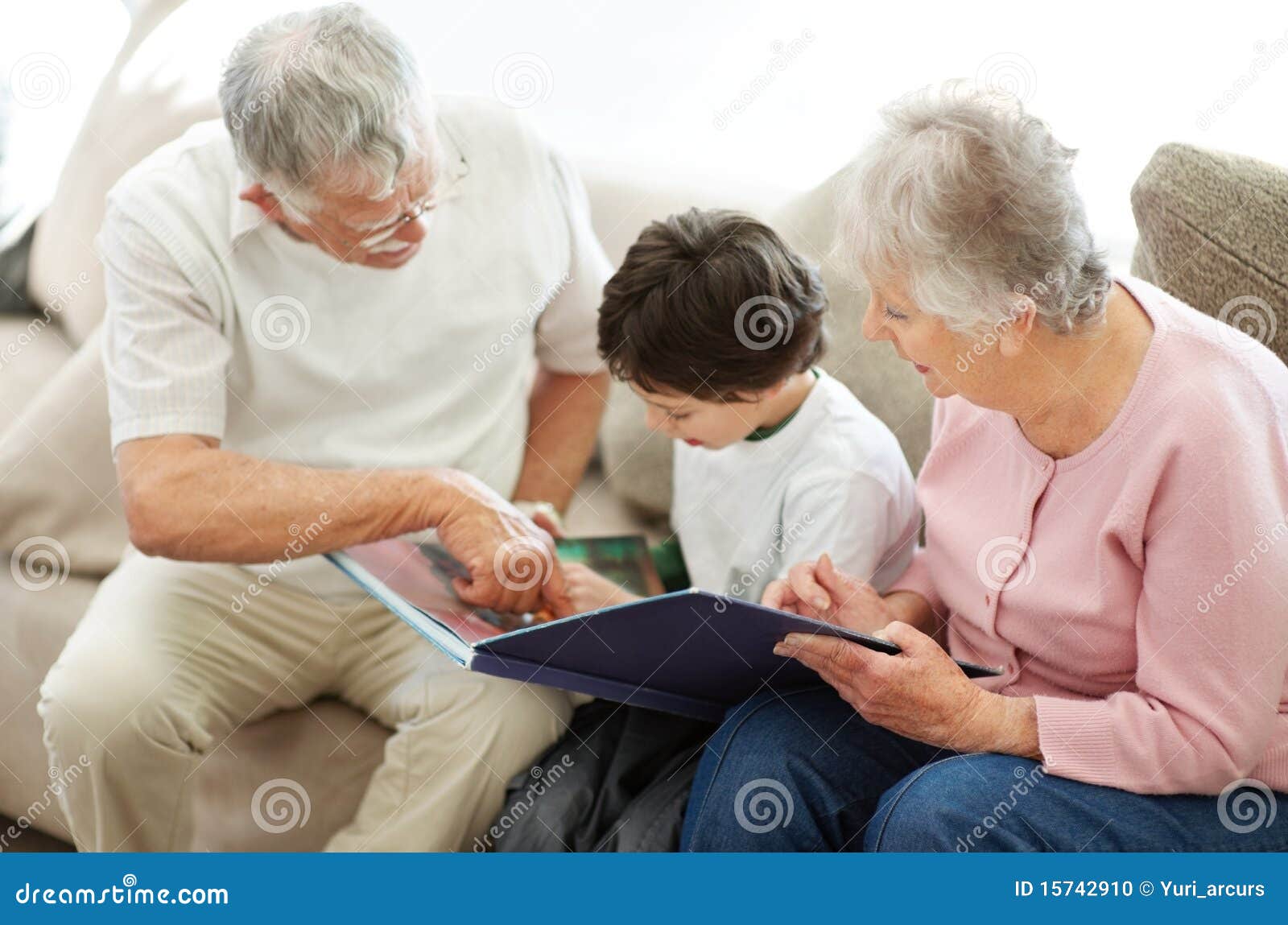 Grandparents Reading with Their Grandson Stock Photo - Image of ...