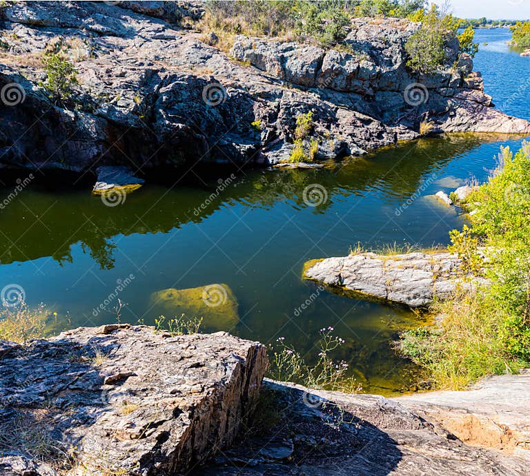 Granite Cliffs Reflecting on Inks Lake at Devils Waterhole Stock Photo ...