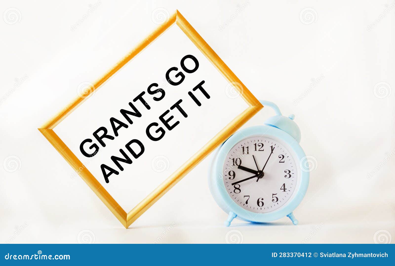 Grants Go and Get it Written on a Frame, on a Desktop with a Clock ...