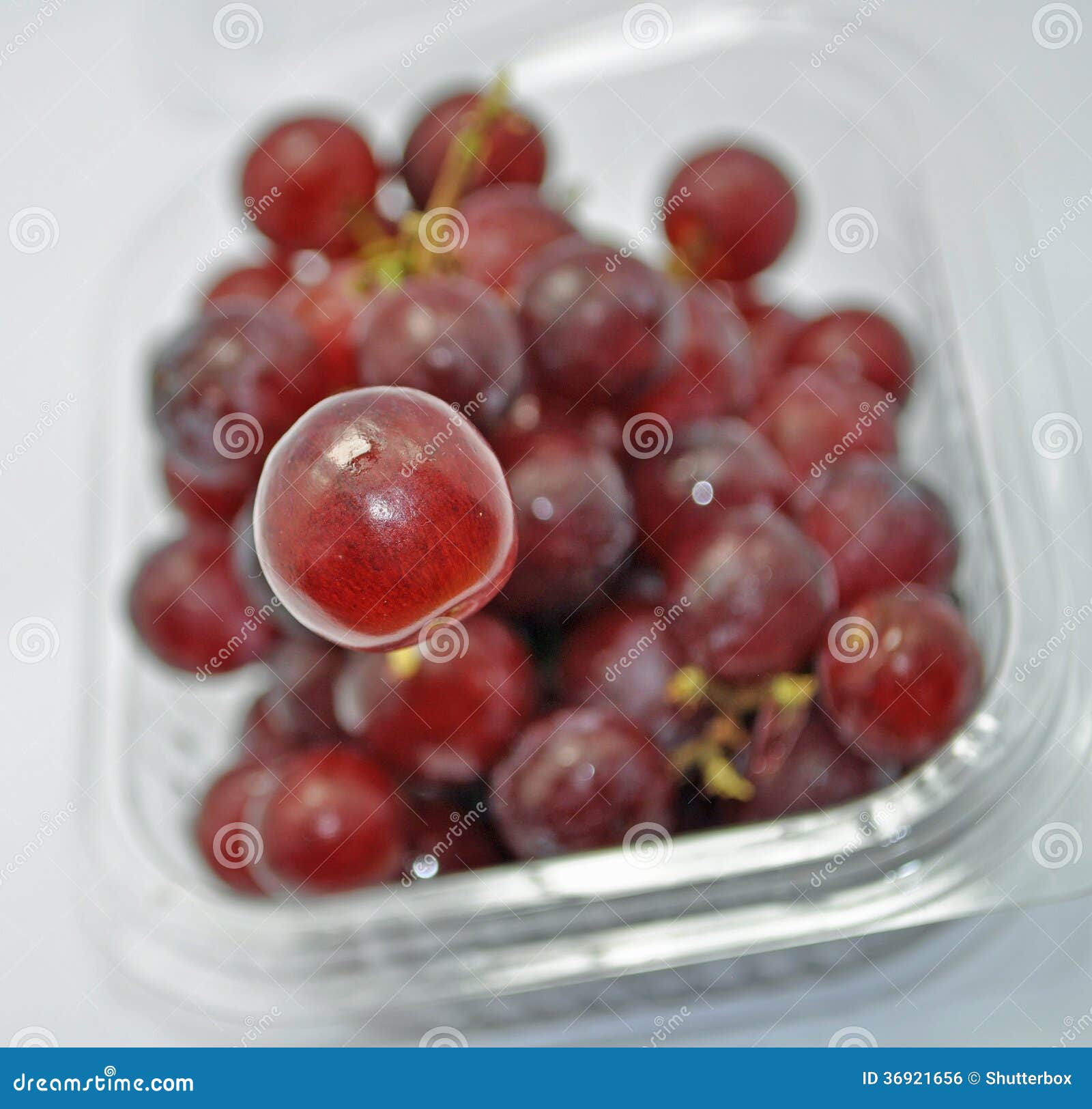 Grape Floating Up from Retail Package Stock Photo - Image of bunch ...