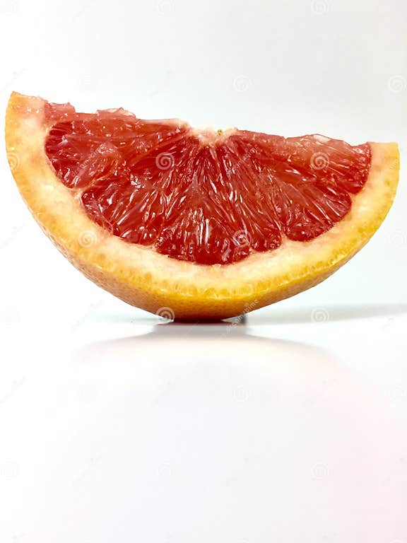 Grapefruit Wedge on a White Surface Stock Photo - Image of food, sour ...