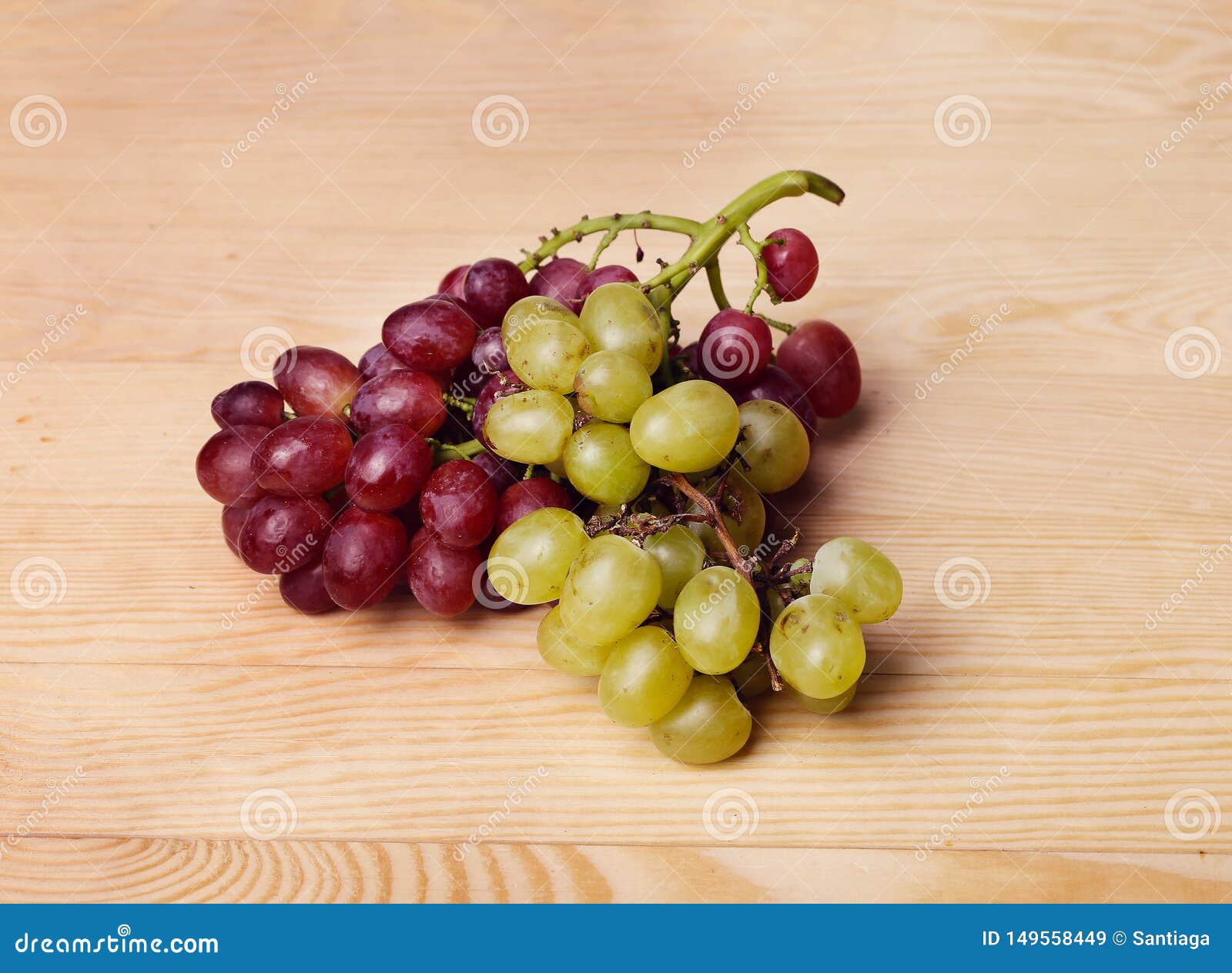 Grapes on a wooden table stock image. Image of grapevine - 149558449