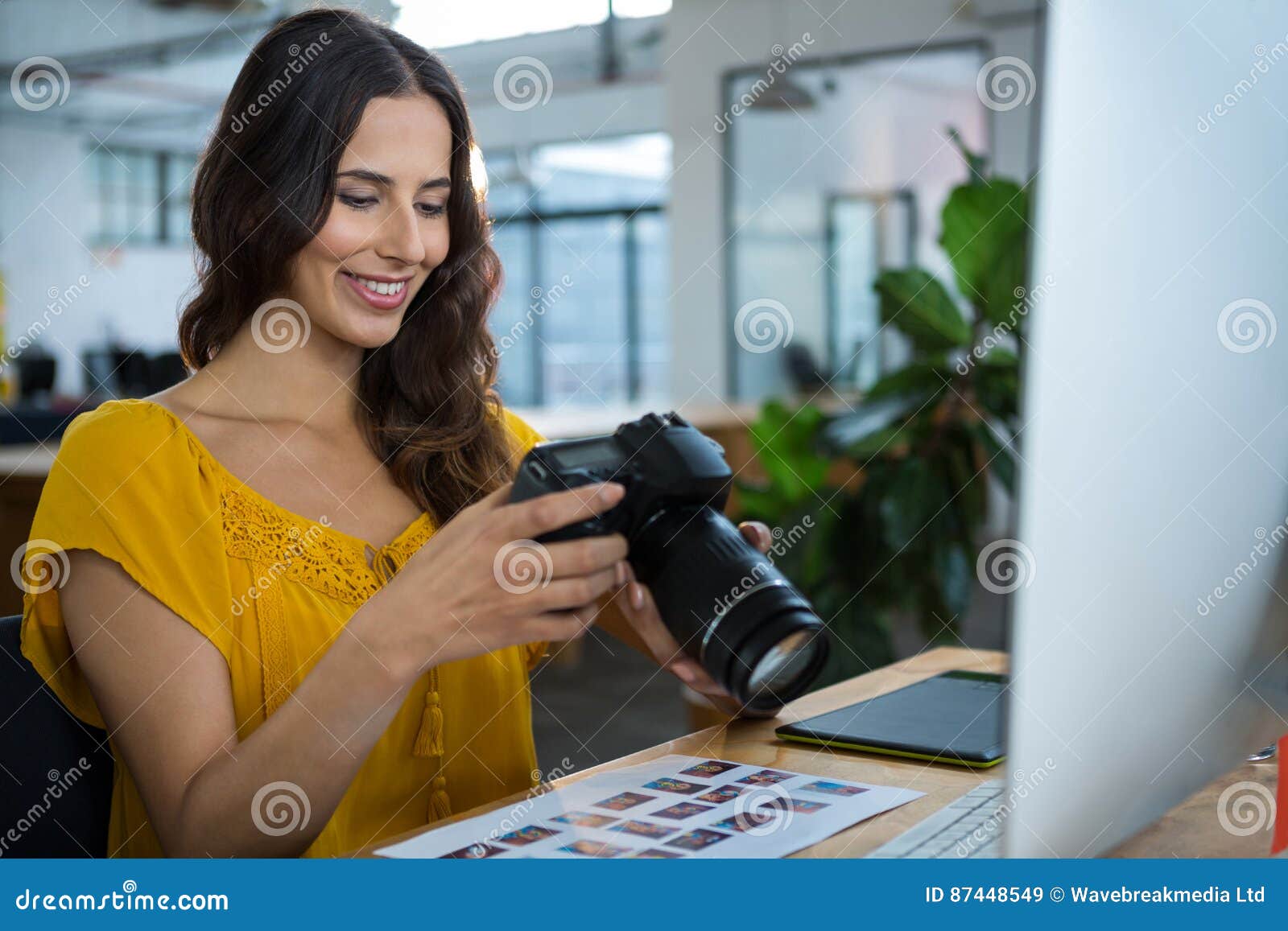 Graphic Designer Looking at Pictures in Digital Camera Stock Image ...