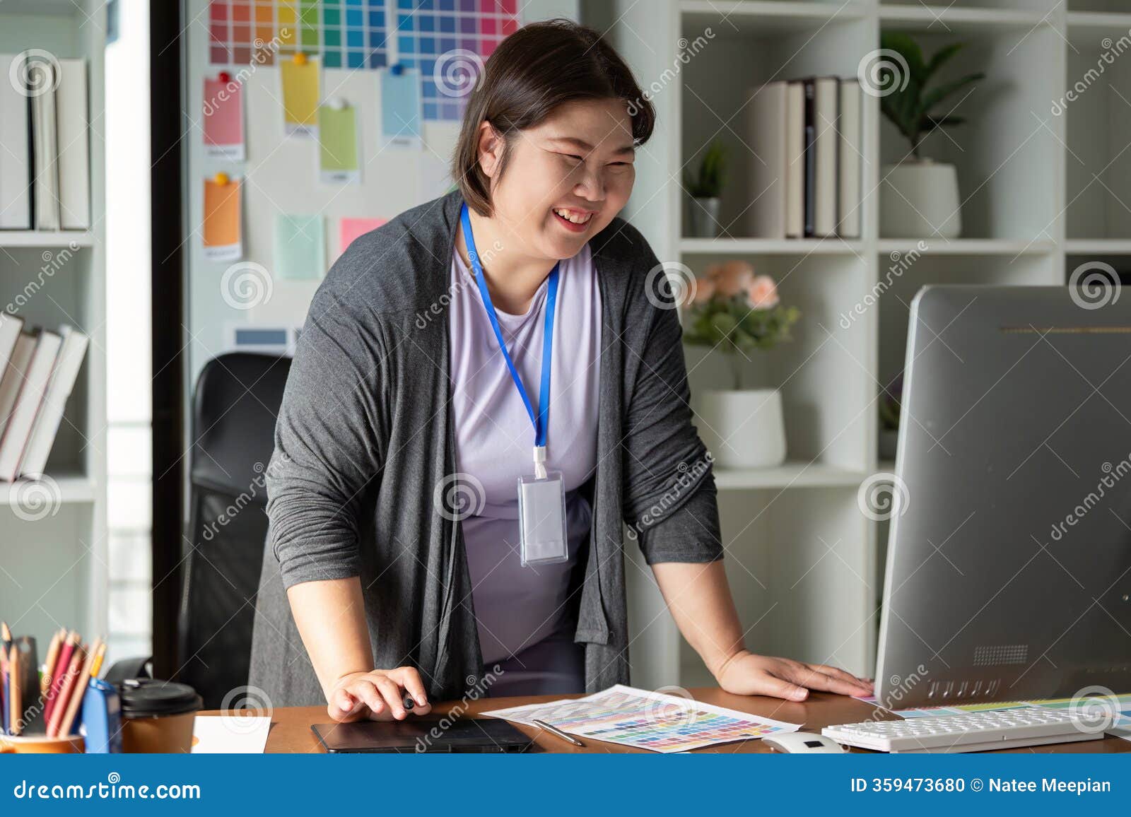 Graphic Designer Smiling while Working at a Colorful Creative Office ...