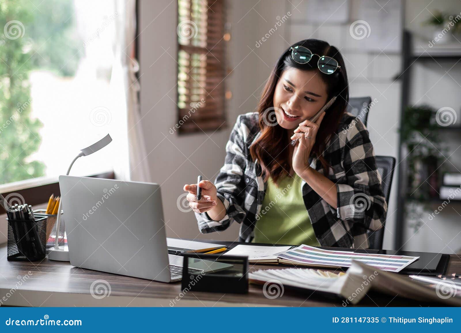 Graphic Designer Talk about Work with Mobile Phone at Office Stock ...