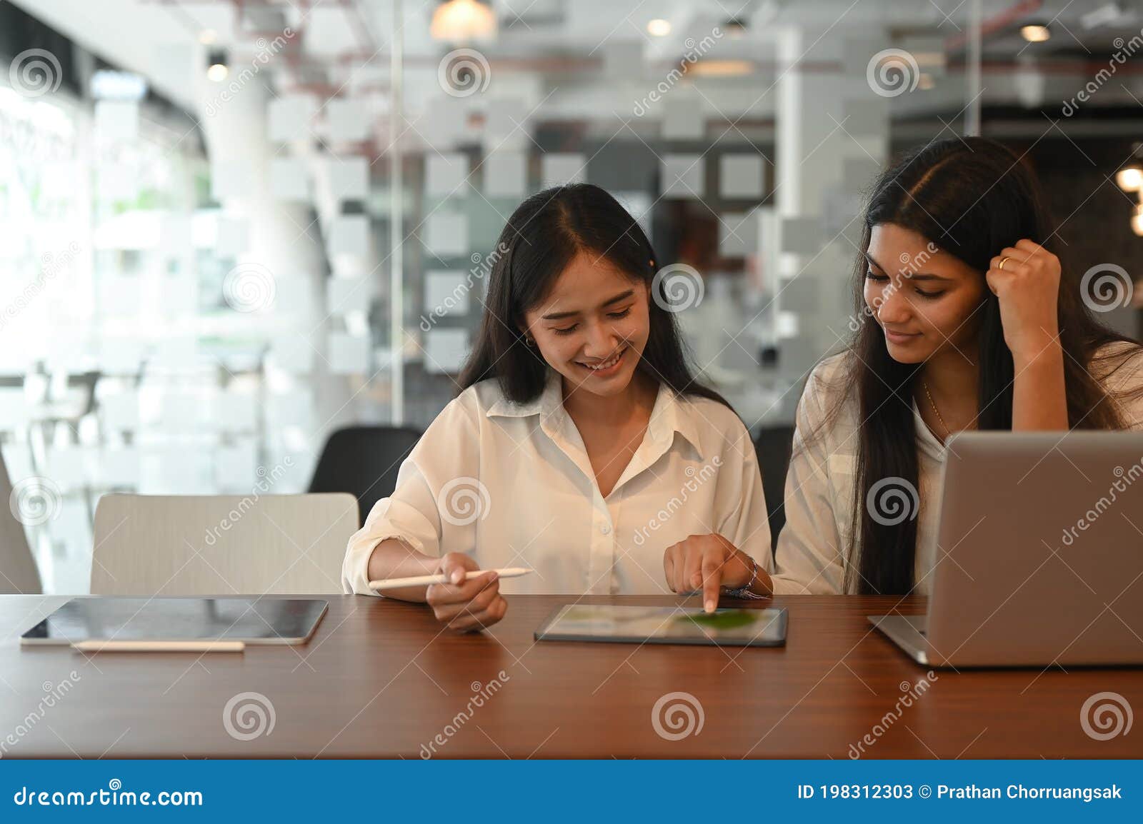 Graphic Designer Team are Working Together with a Computer Laptop and ...