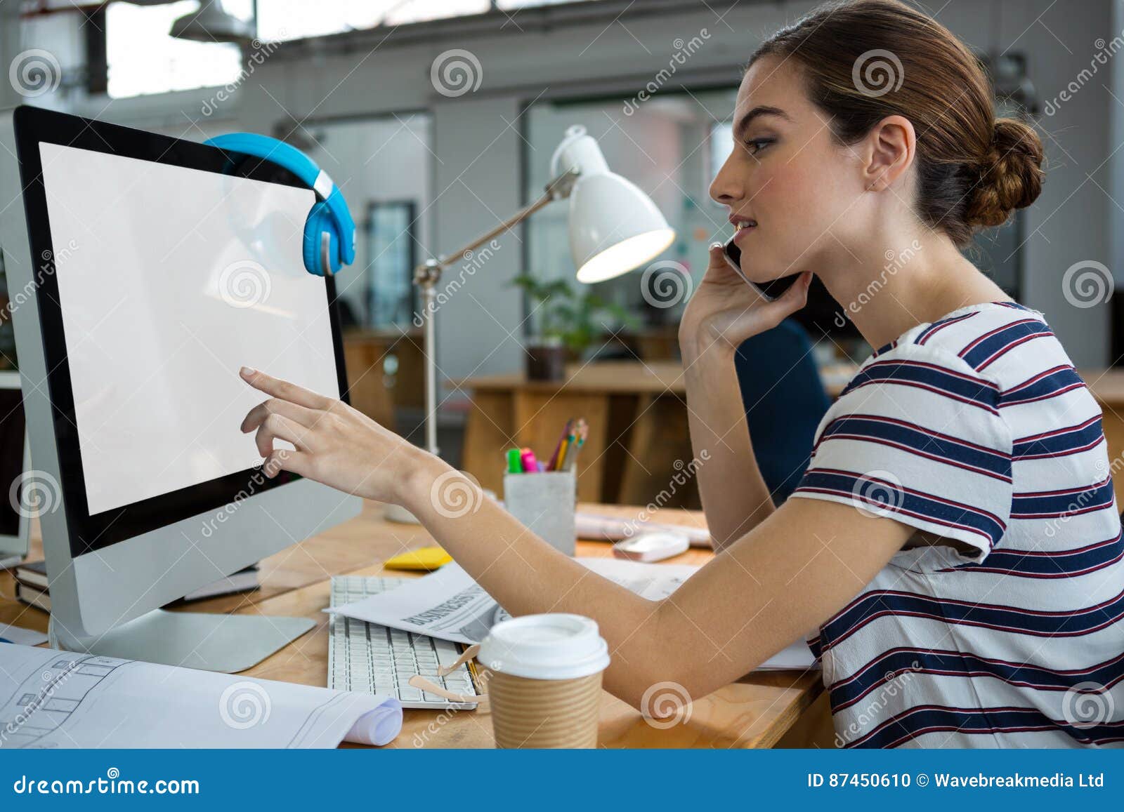 Graphic Designer Using Computer while Talking on Mobile Phone Stock ...