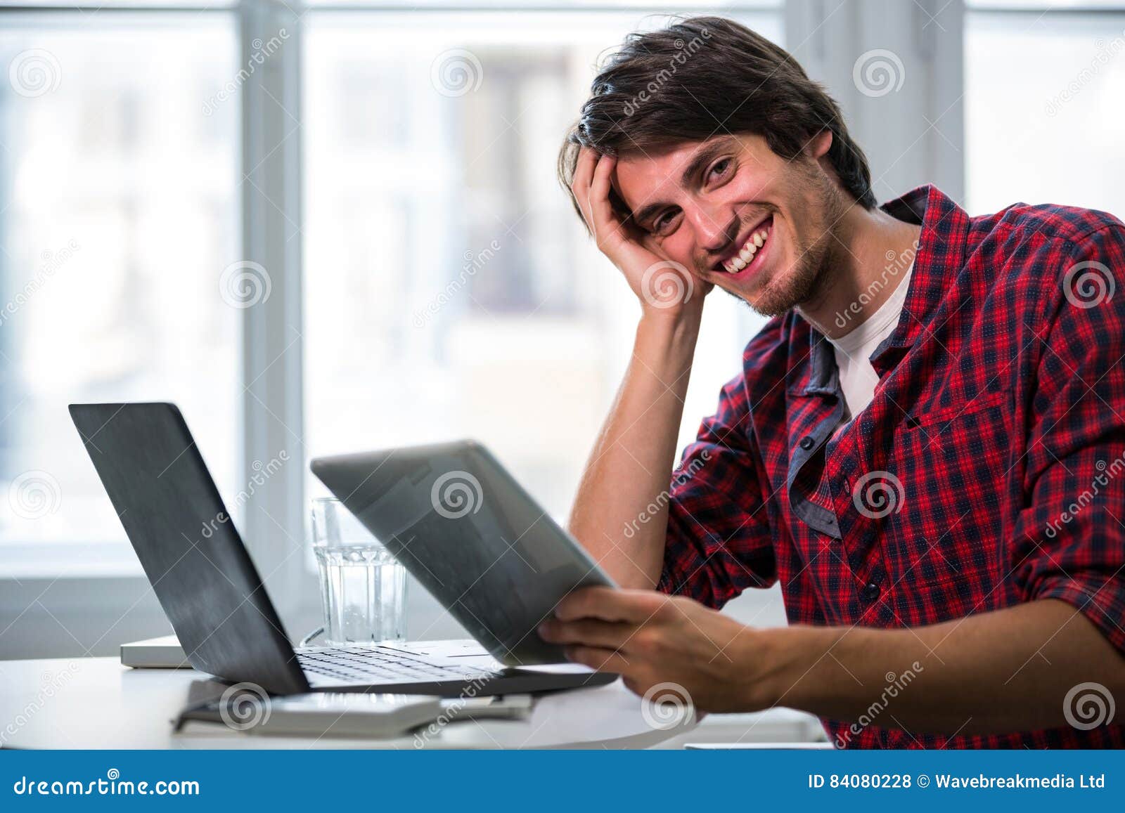 Graphic Designer Using Laptop and Digital Tablet at His Desk Stock ...