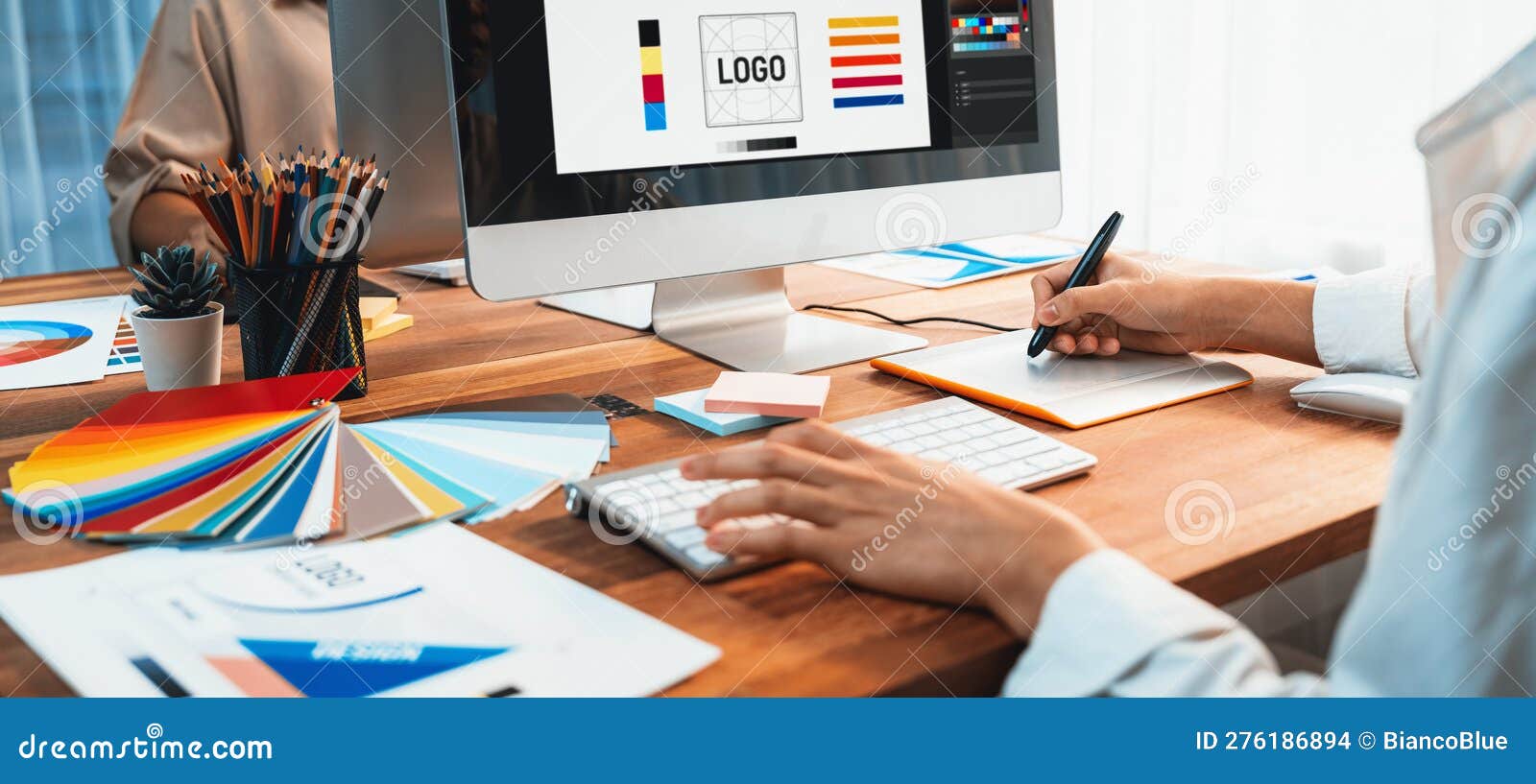 Graphic Designer Works on Computer Laptop with Digital Pen. Scrutinize ...